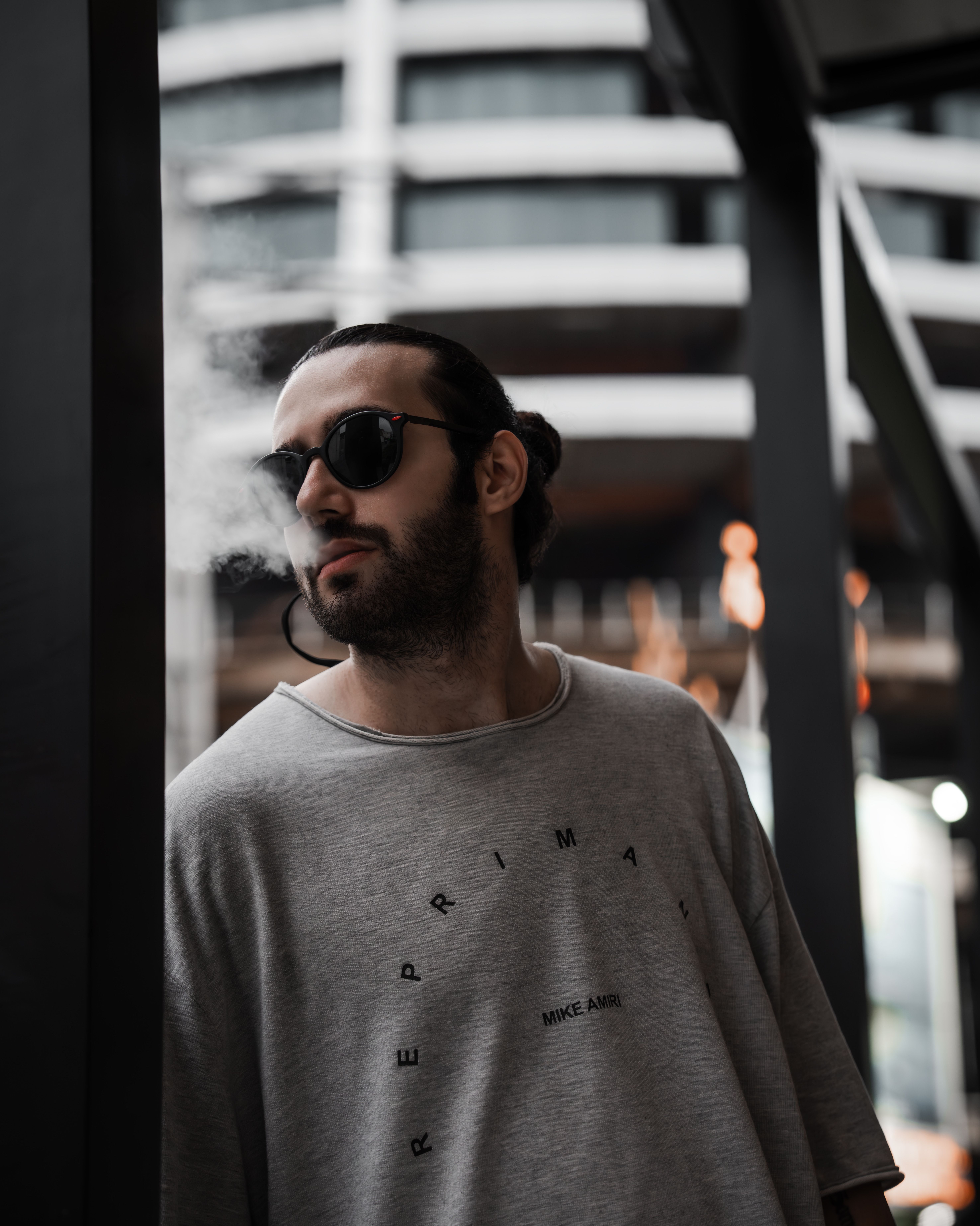 Trendy Man Leaning with Smoke and Sunglasses · Free Stock Photo