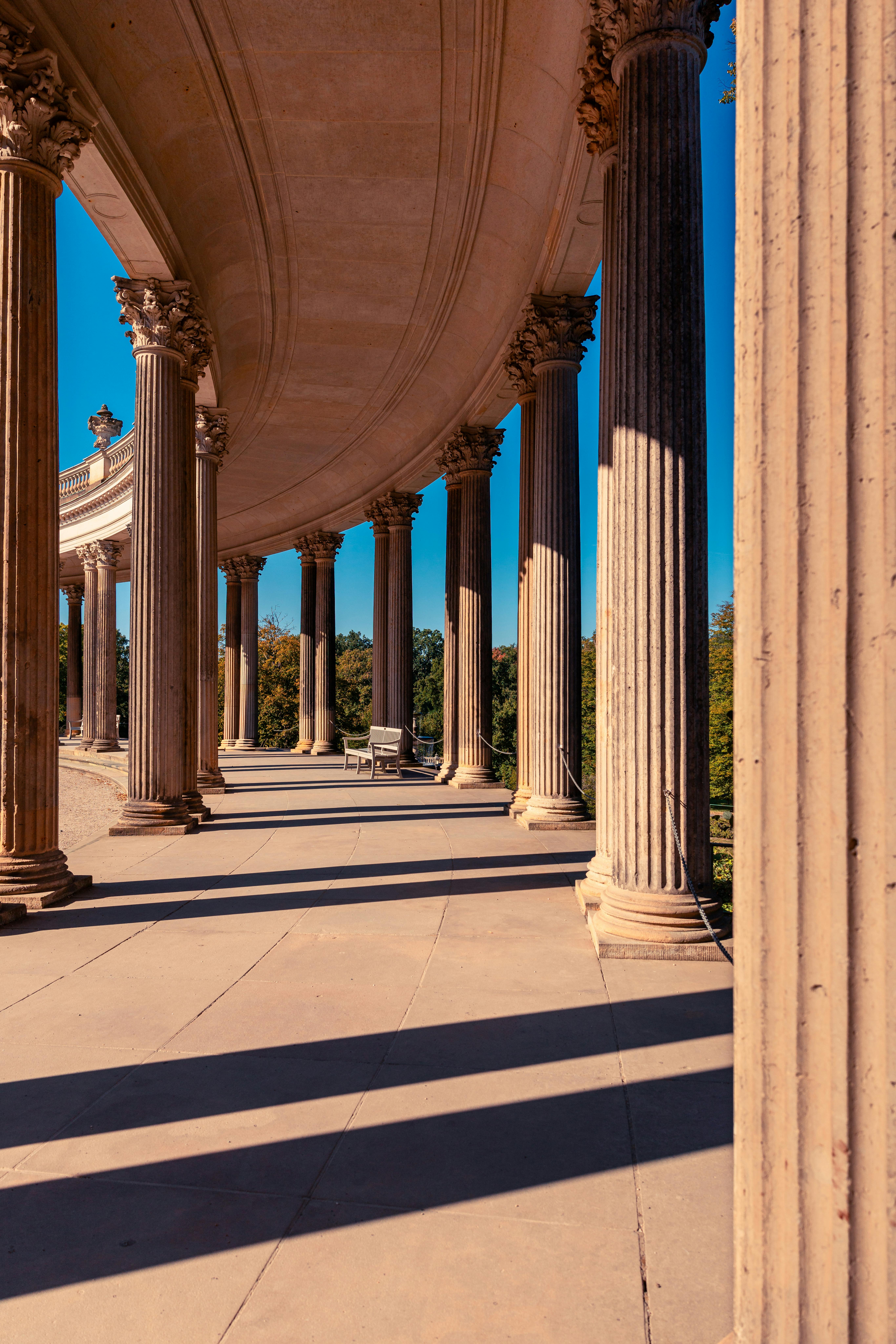 Elegant Classical Columns in Sunlit Colonnade · Free Stock Photo