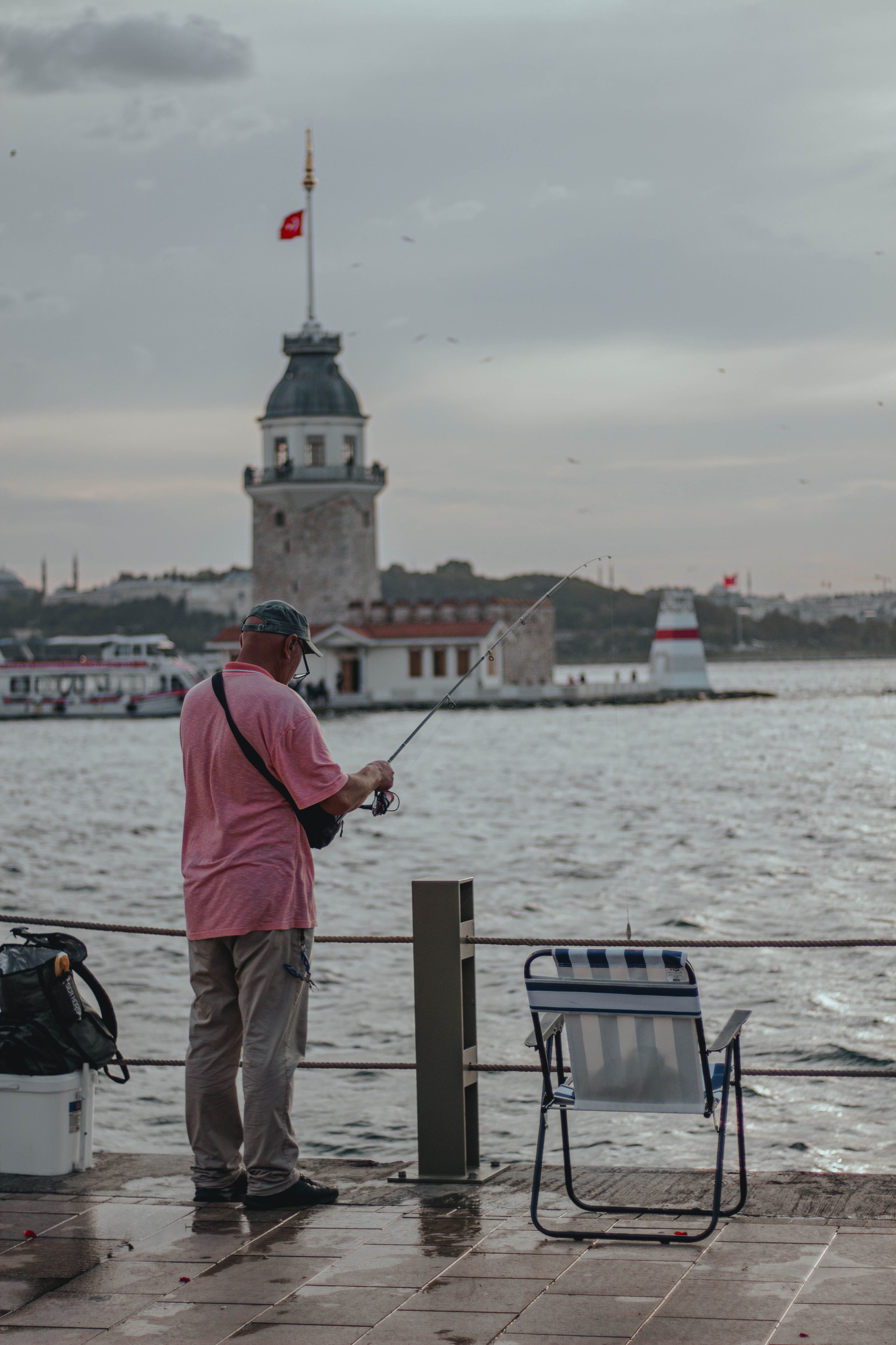 Man Fishing by Maiden's Tower in Istanbul · Free Stock Photo