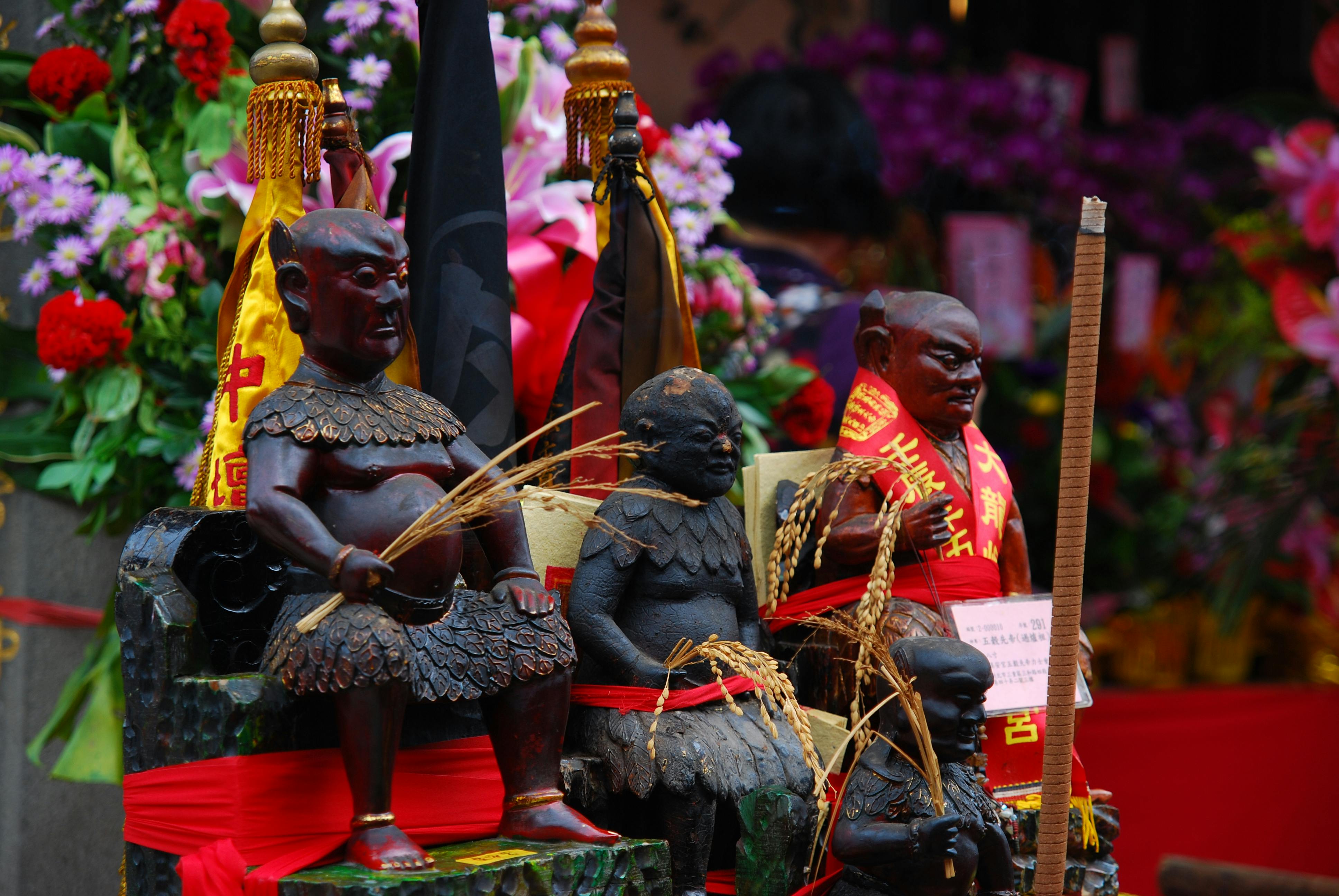 Colorful Asian Statues with Floral Background · Free Stock Photo