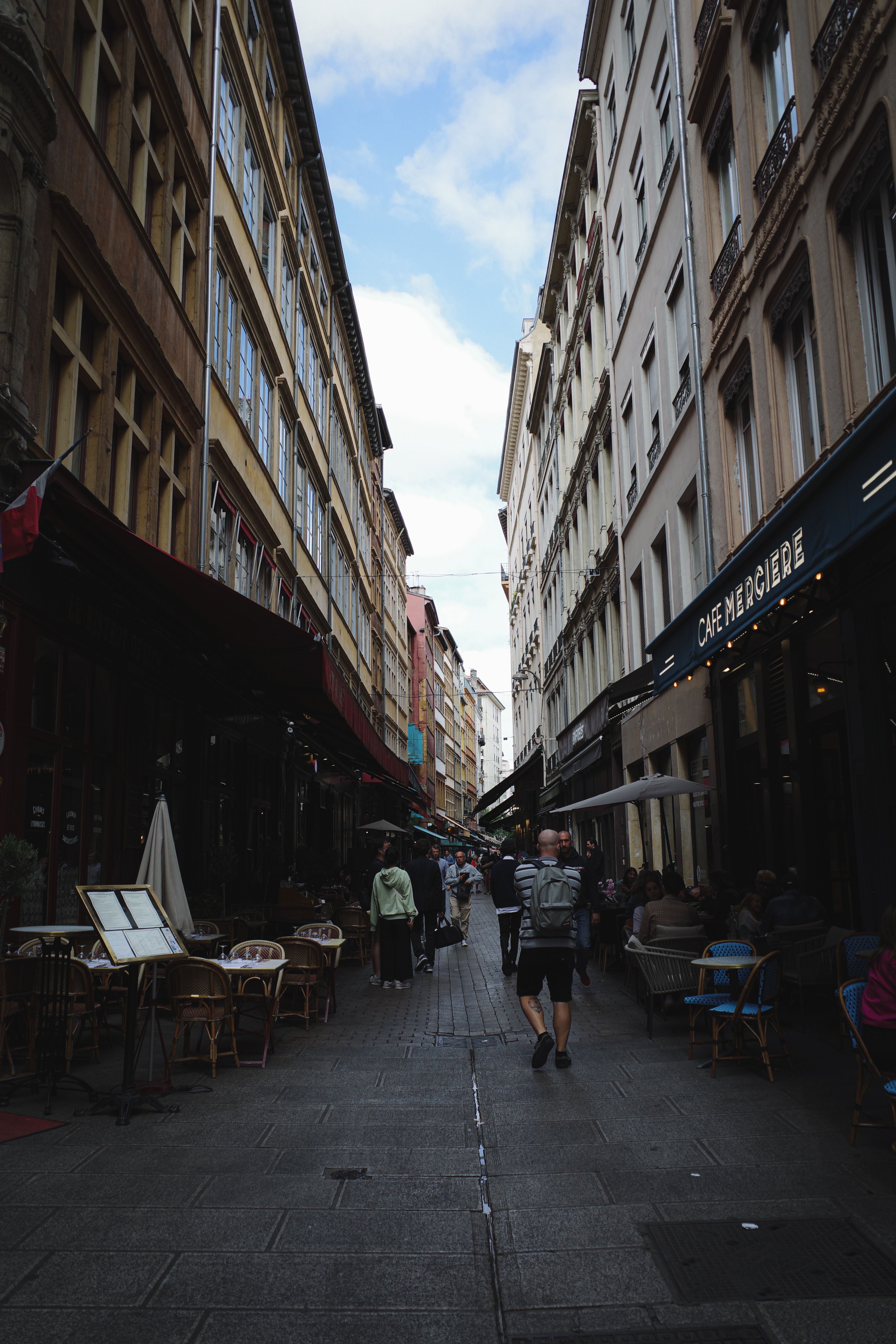 Charming European Street with Outdoor Cafés · Free Stock Photo