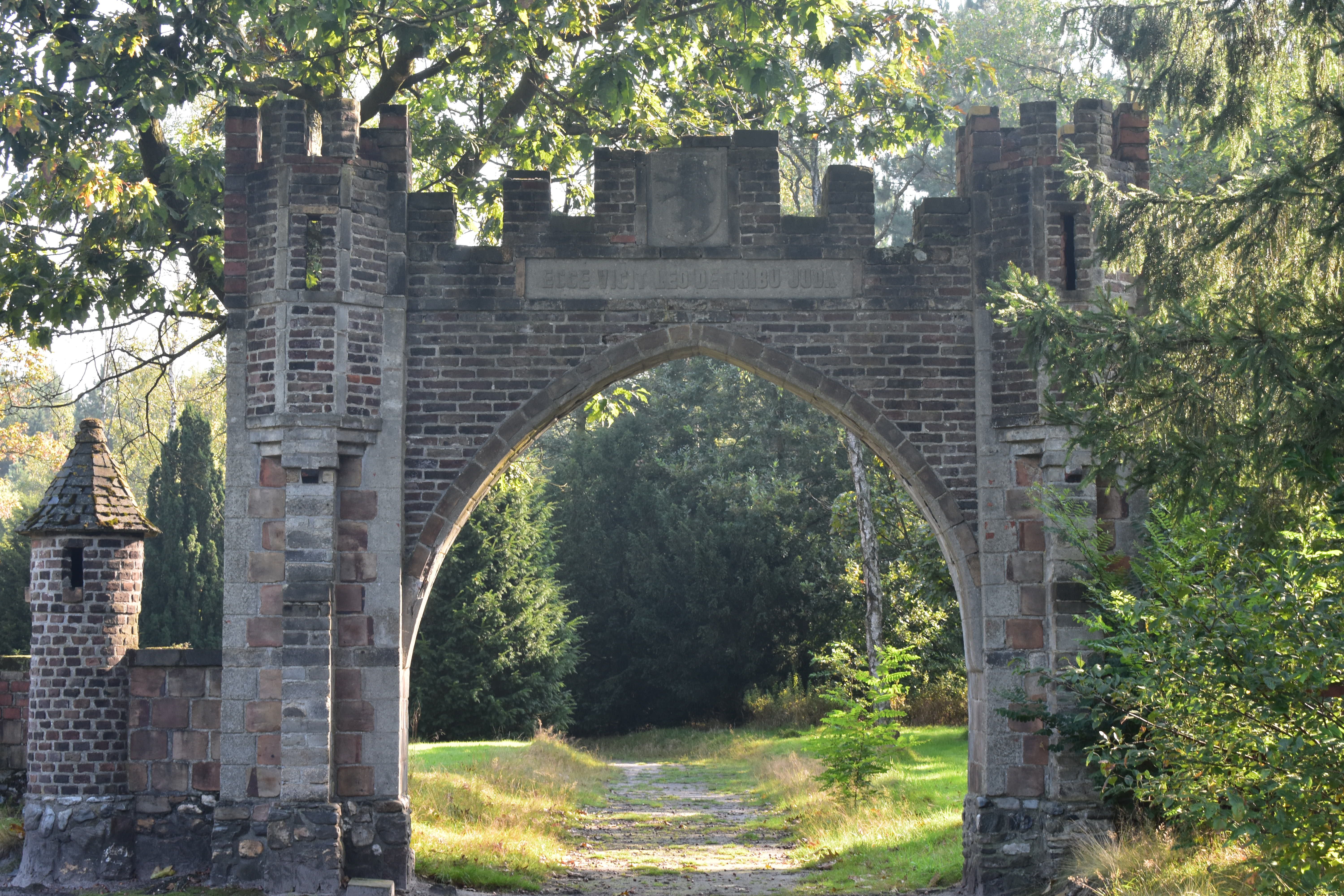 Historic Brick Gate in Lush Forest Setting · Free Stock Photo