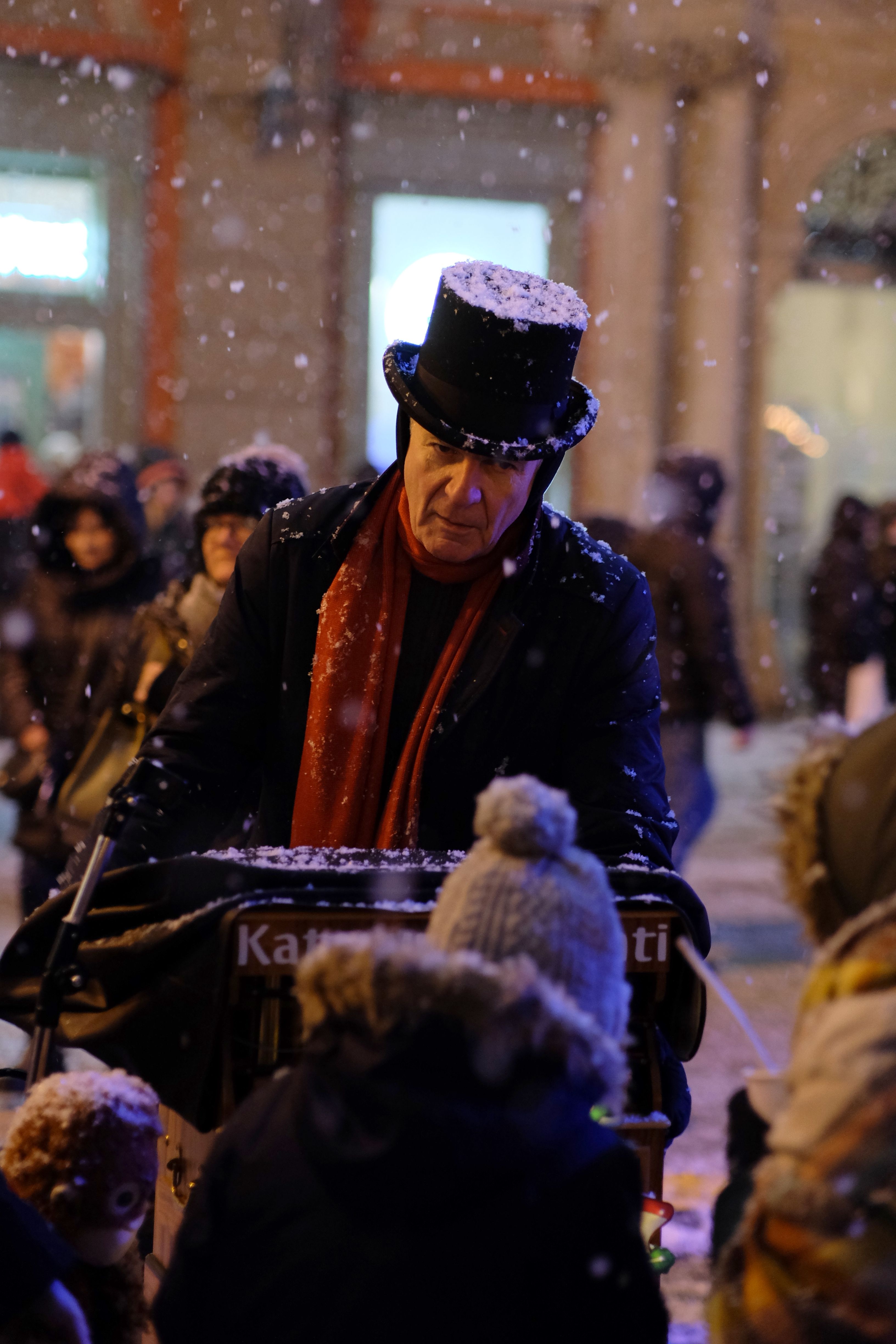 Street Performer Entertains in Snowy Winter Evening · Free Stock Photo