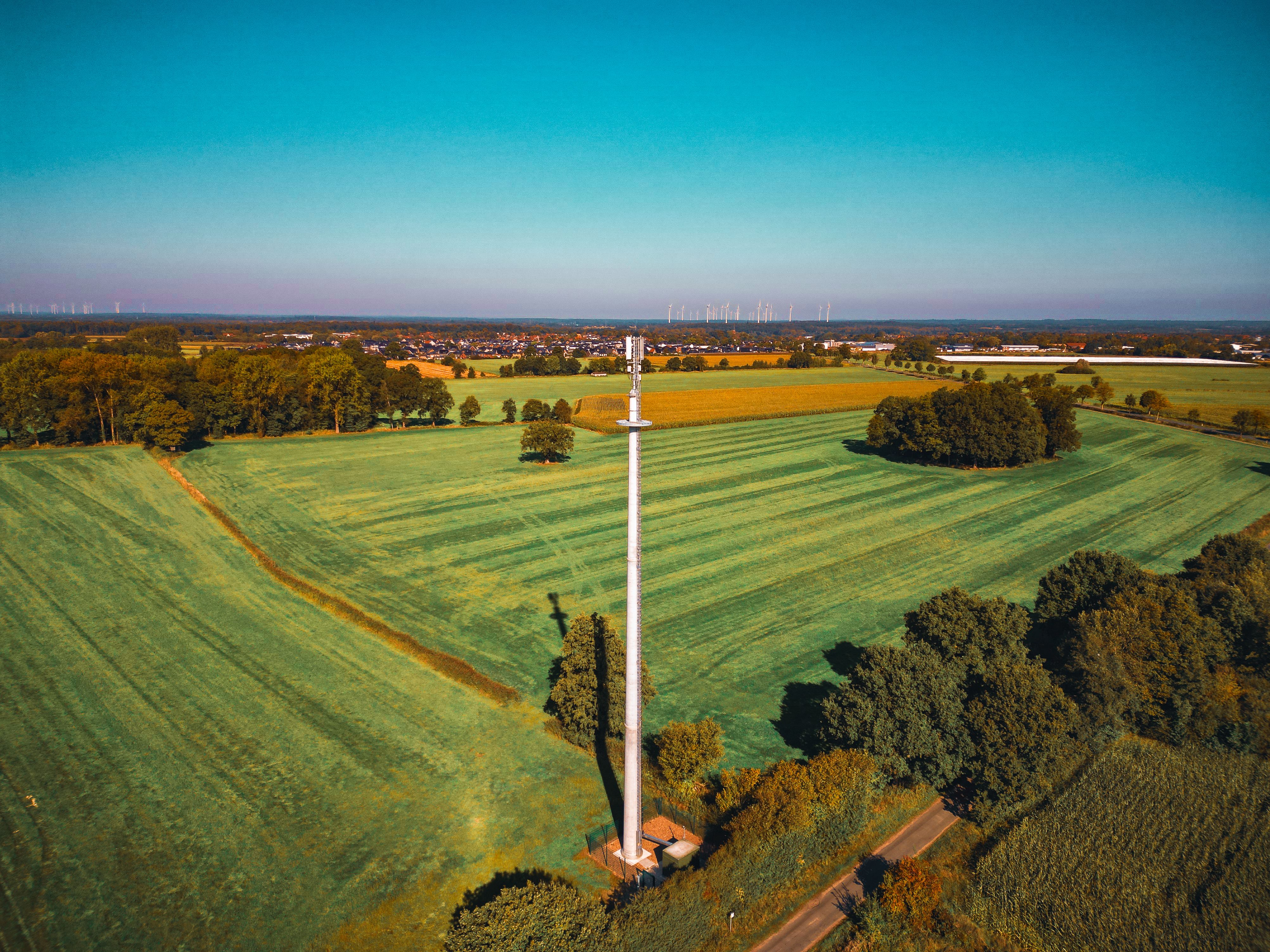 Aerial View of Communication Tower in Green Fields · Free Stock Photo