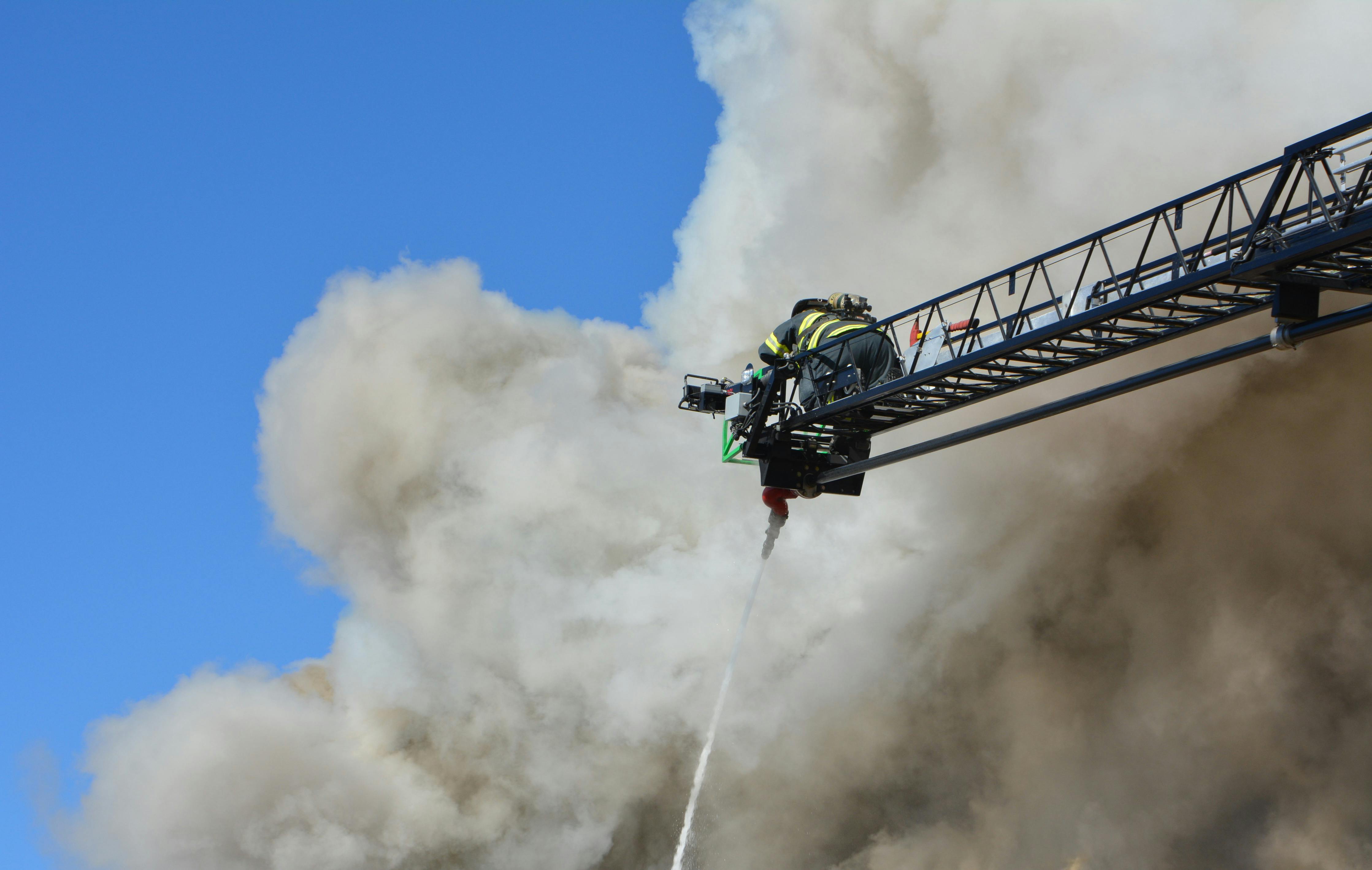Bombeiro Na Escada Combatendo Incêndio Em Meio à Fumaça · Foto ...