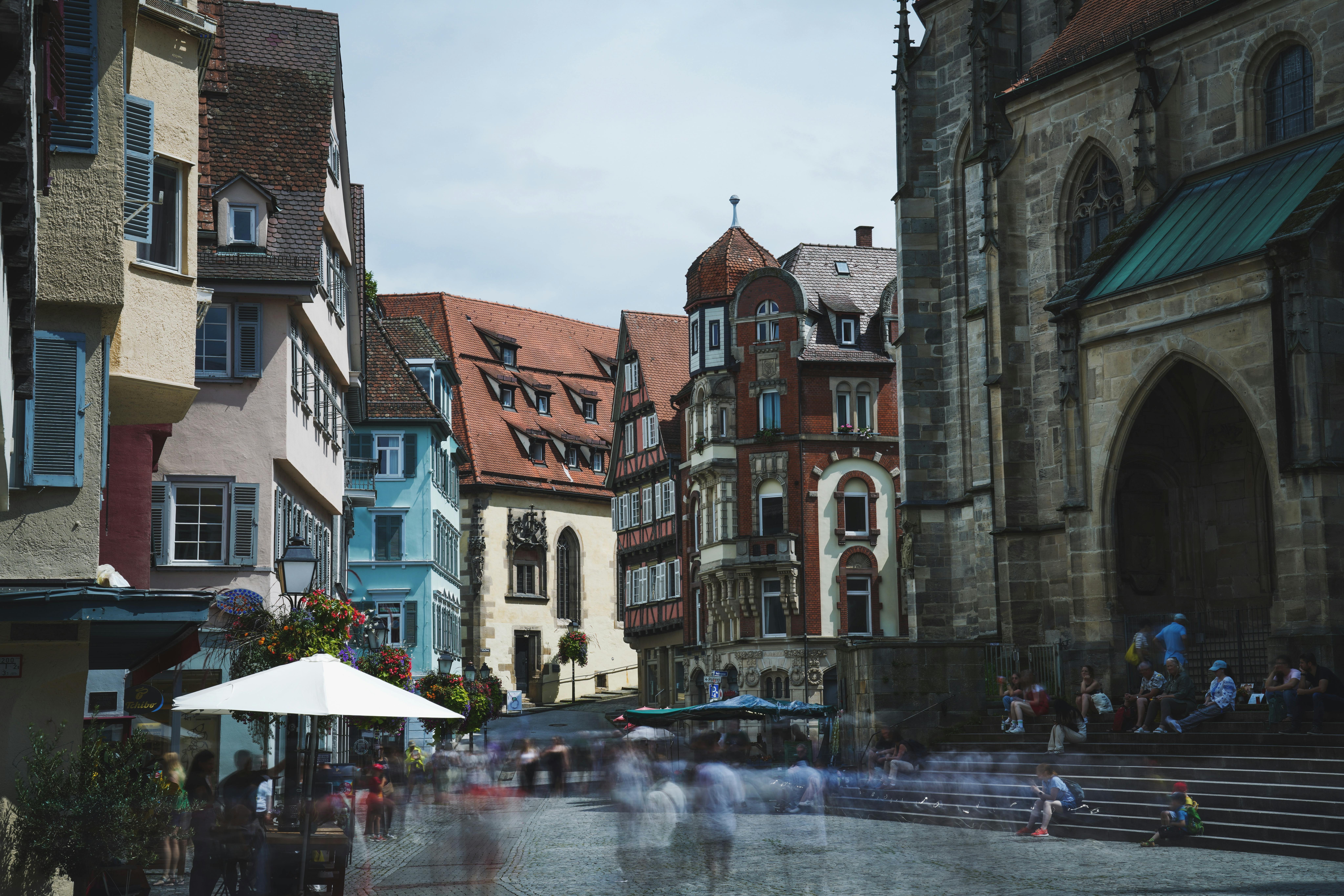 Historic European Town Street with Blurred Passersby · Free Stock Photo