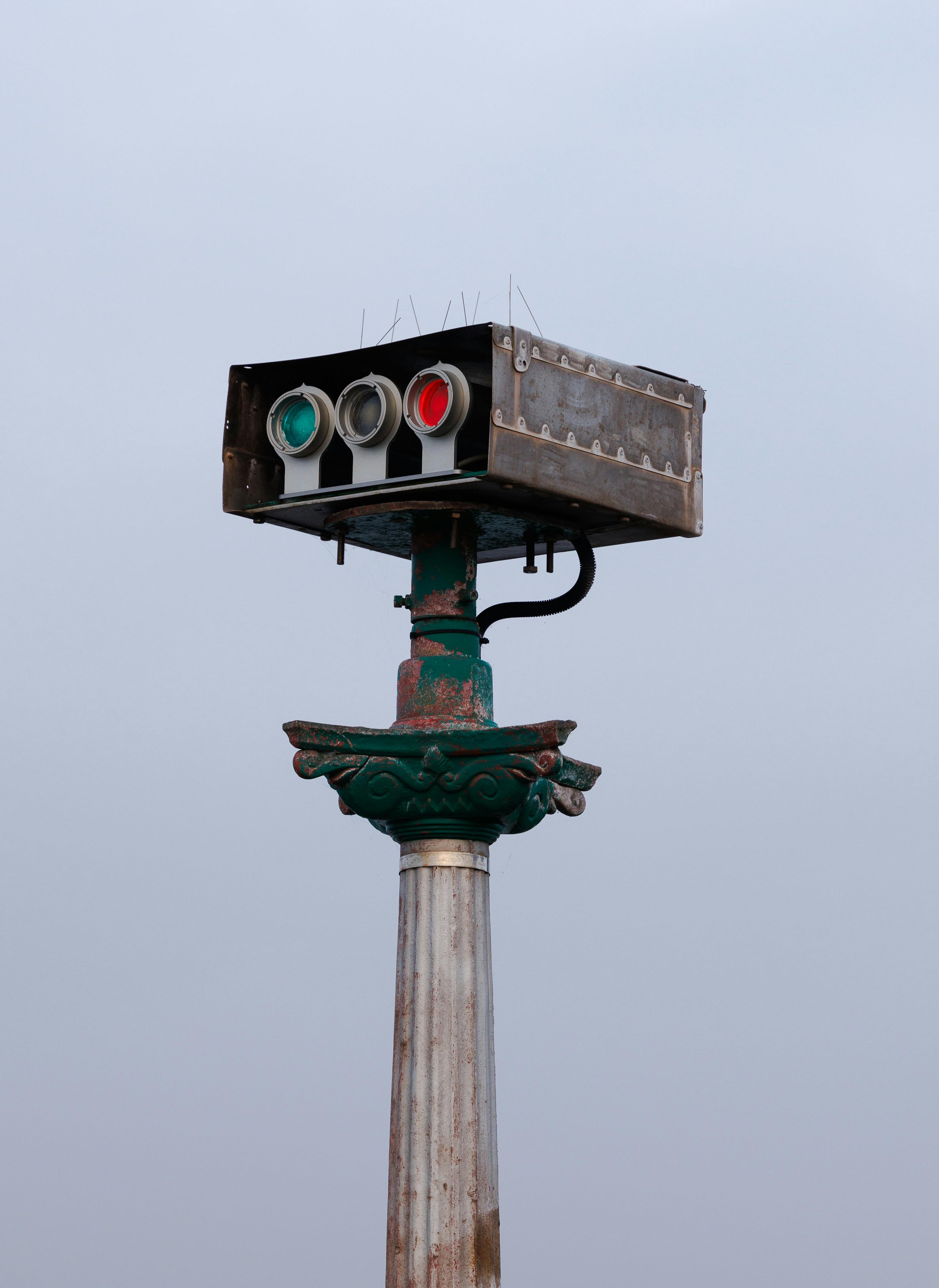 Vintage Rusty Traffic Light Tower Against Clear Sky · Free Stock Photo