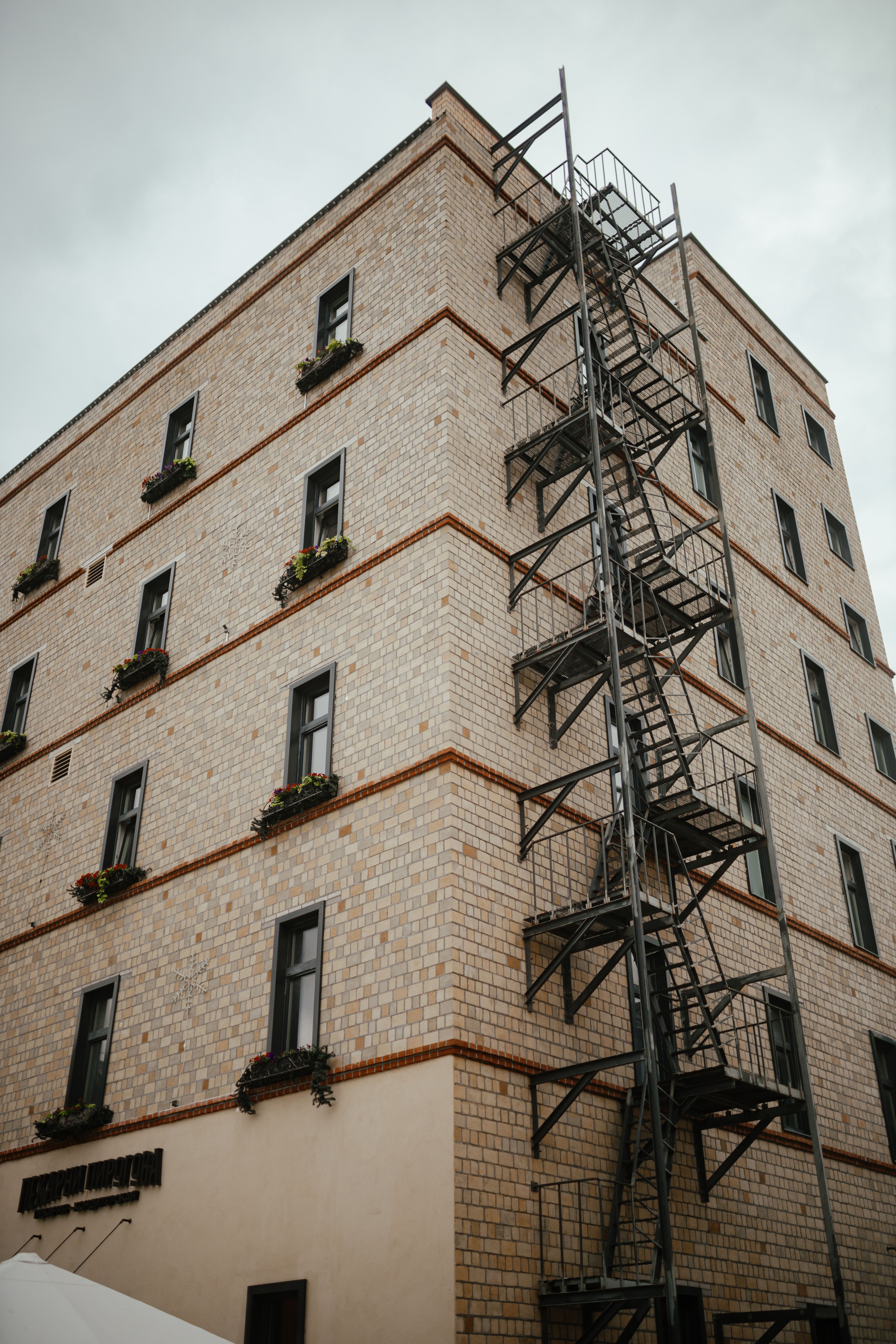 Historic Brick Building with Metal Fire Escape · Free Stock Photo