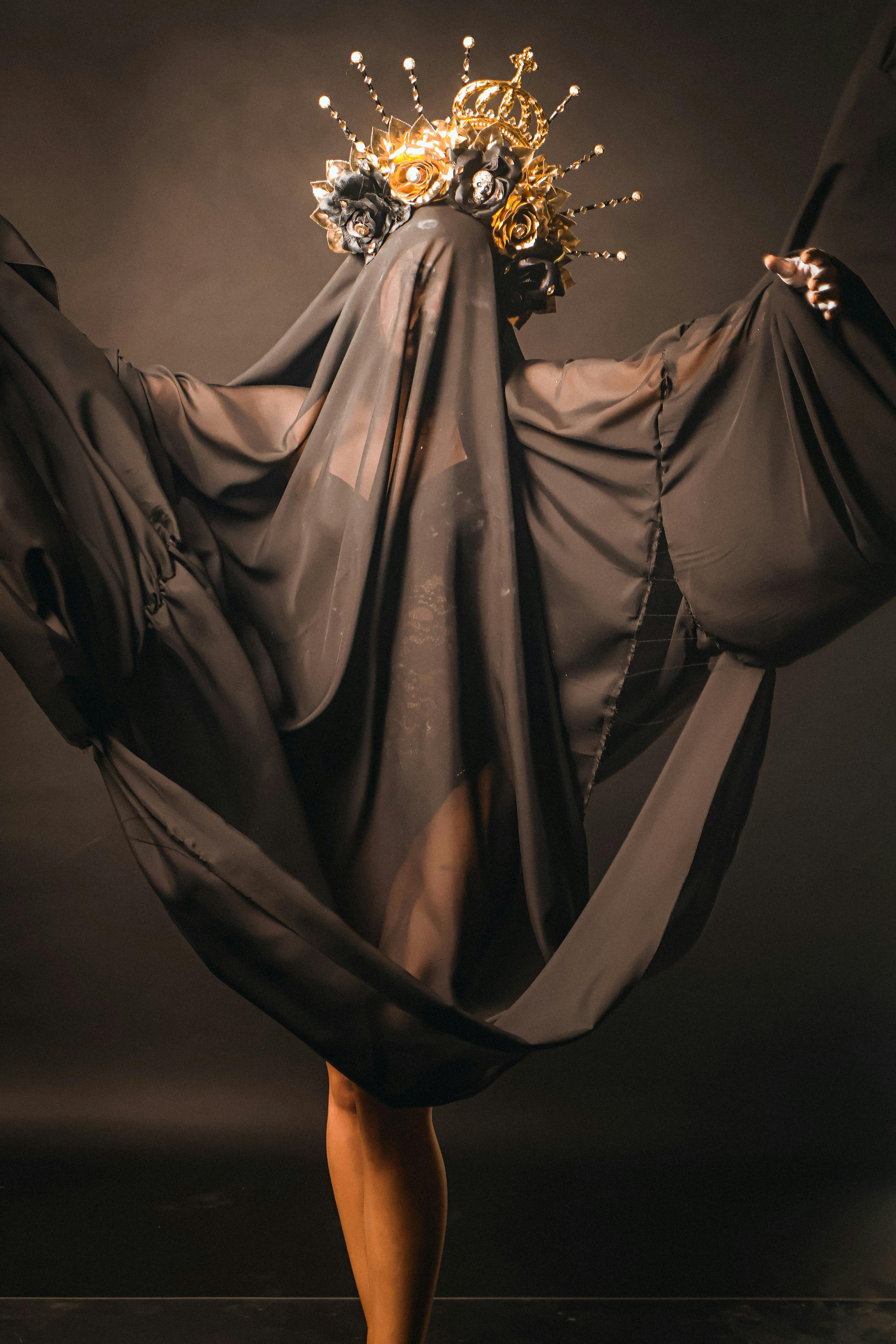 Elegant Veiled Dancer in Flowing Black Robe · Free Stock Photo