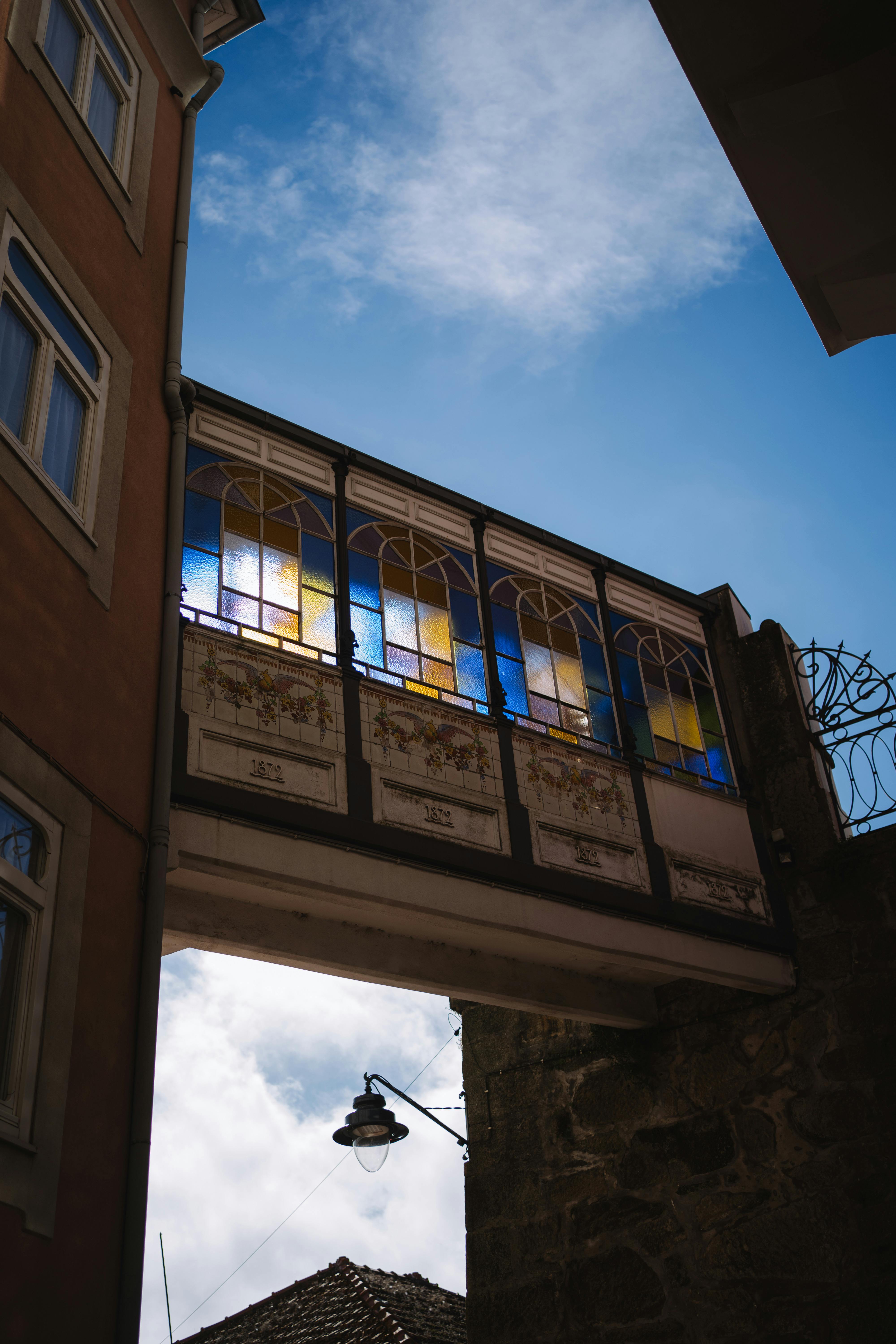 Colorful stained glass bridge under blue sky · Free Stock Photo