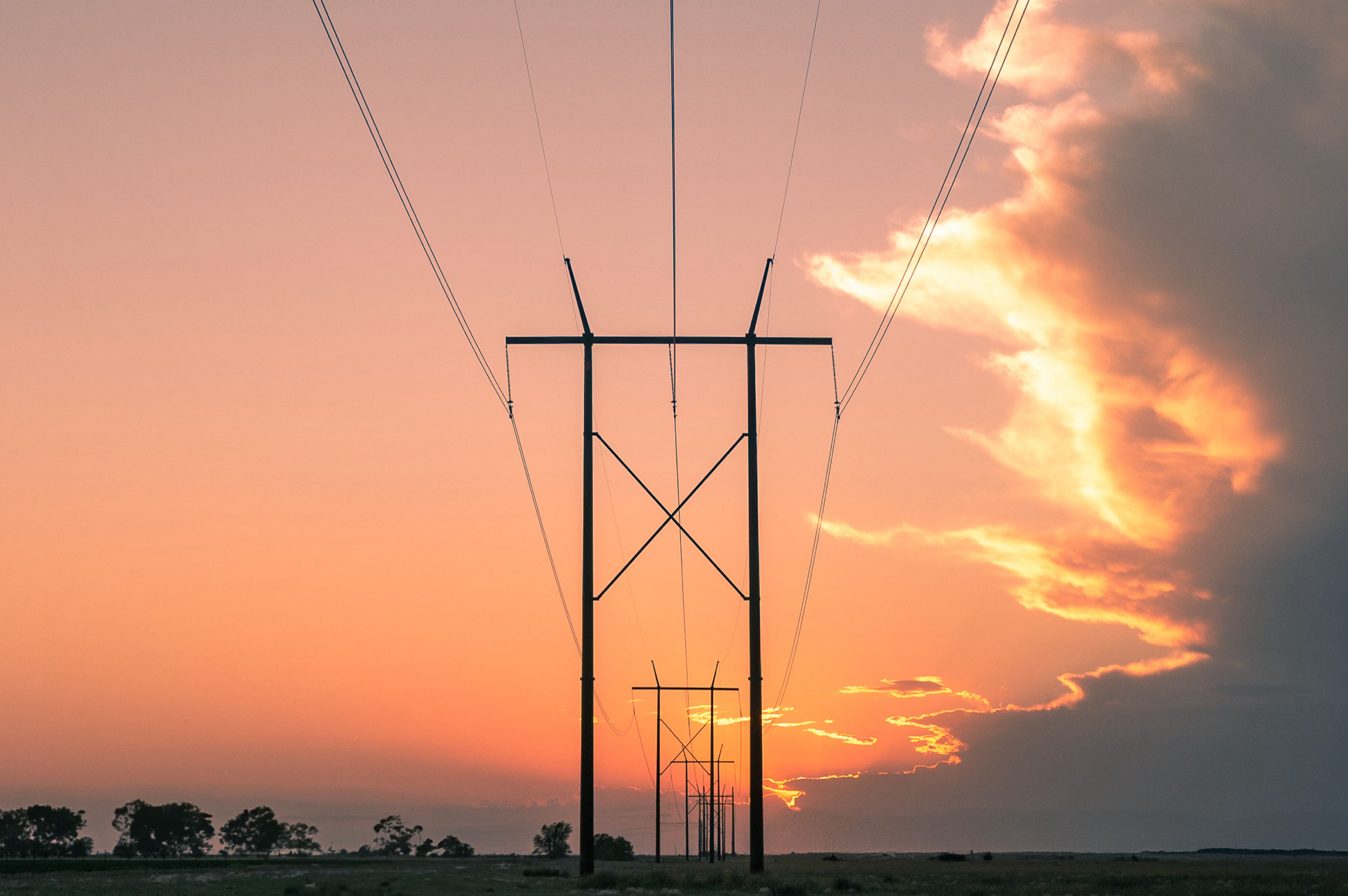 Sunset Silhouette of Power Lines in Open Field · Free Stock Photo