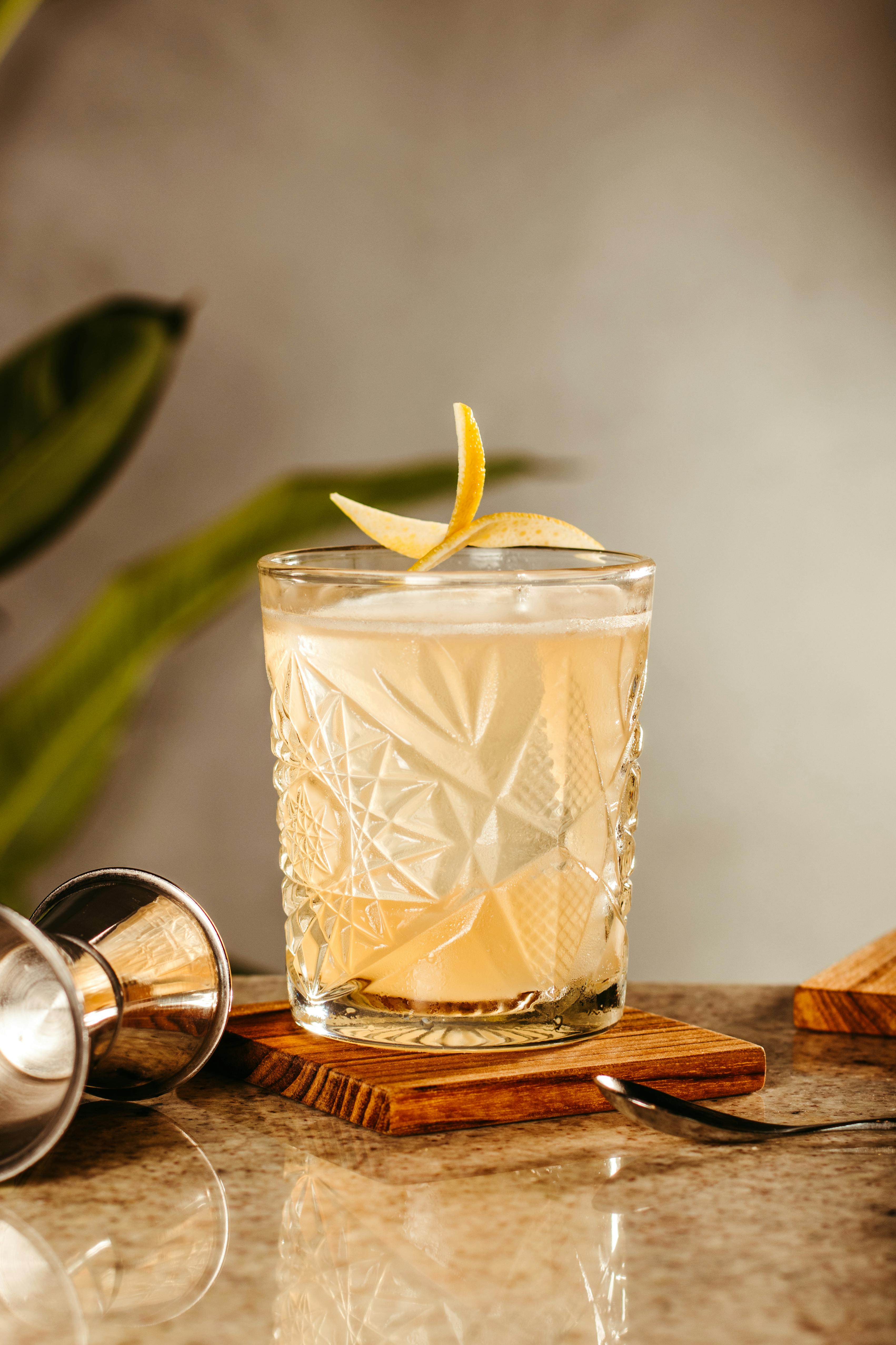 Elegant Cocktail with Lemon Twist in Crystal Glass · Free Stock Photo