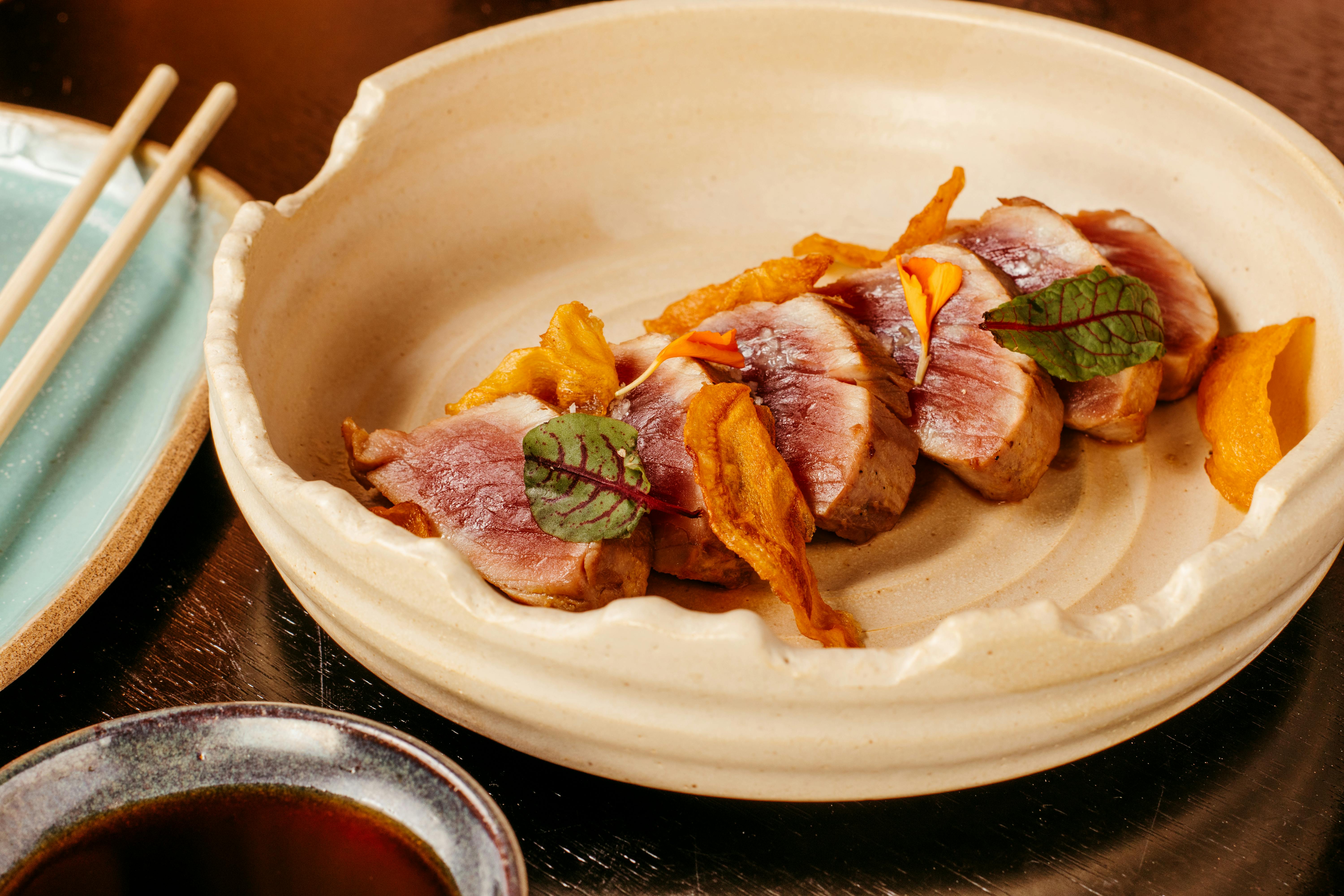Exquisite Sliced Duck Breast in Elegant Dish · Free Stock Photo
