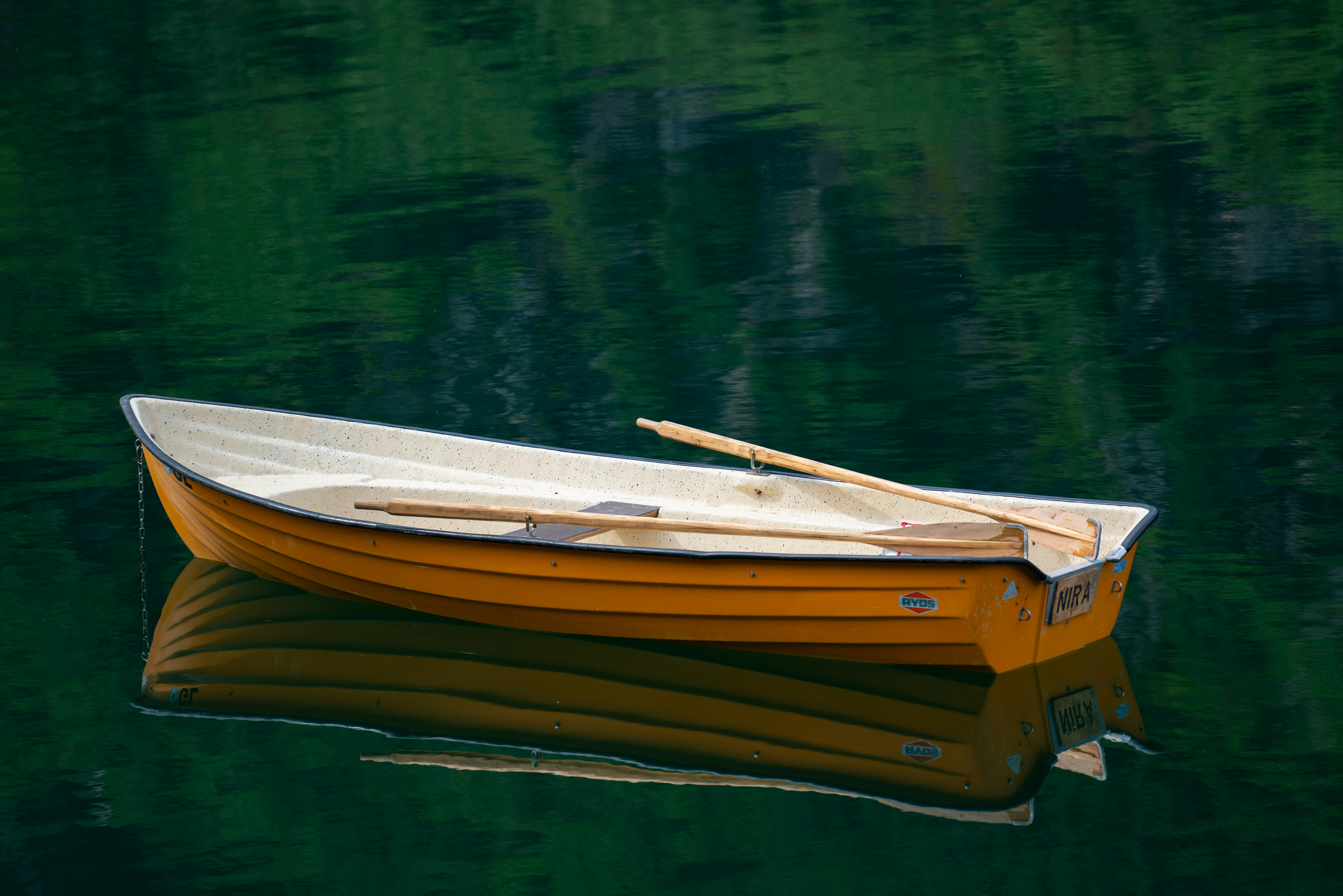 Peaceful Rowboat on Calm Lake Water · Free Stock Photo