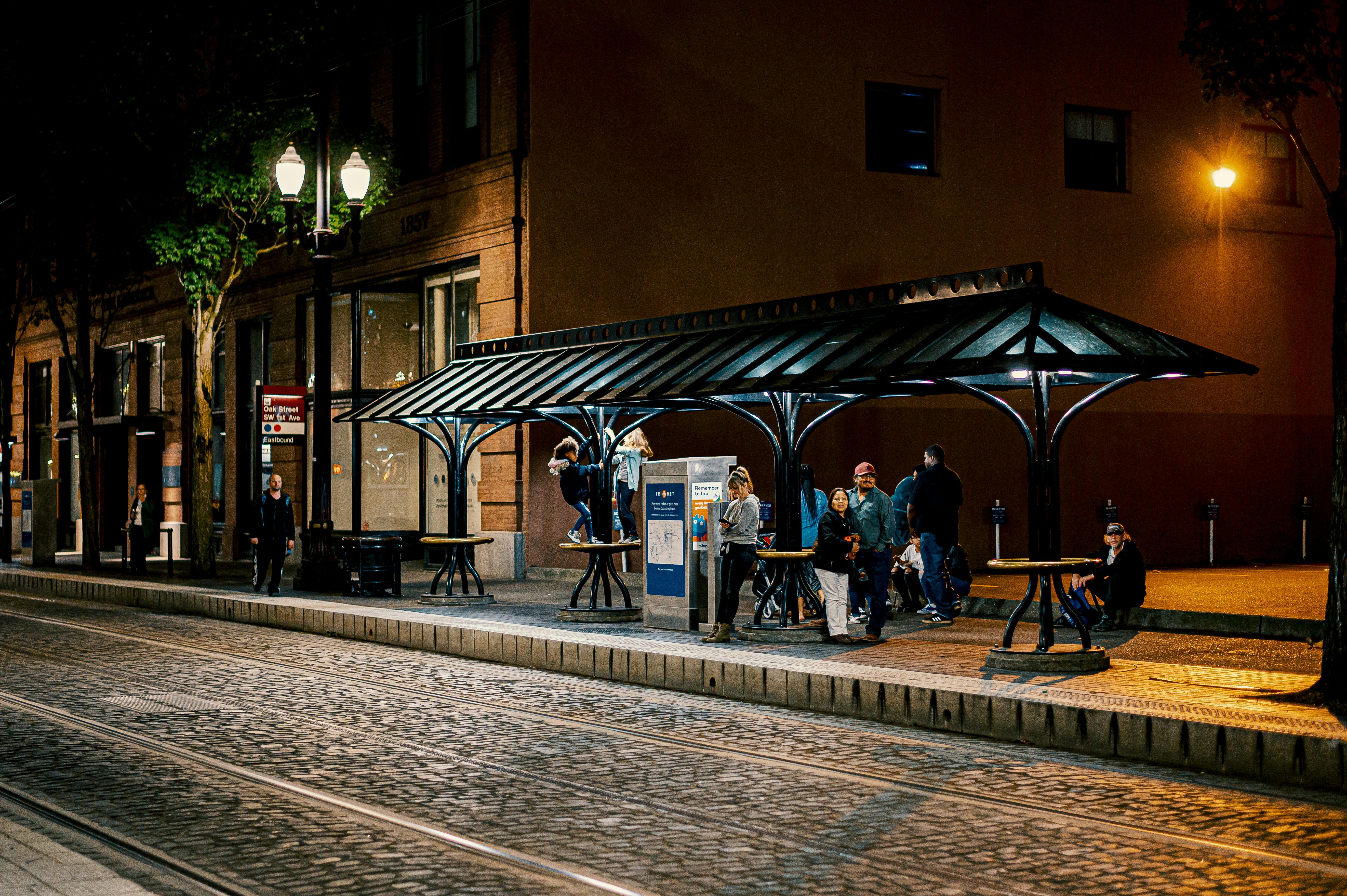 Photo of People on Waiting Shed During Nighttime · Free Stock Photo