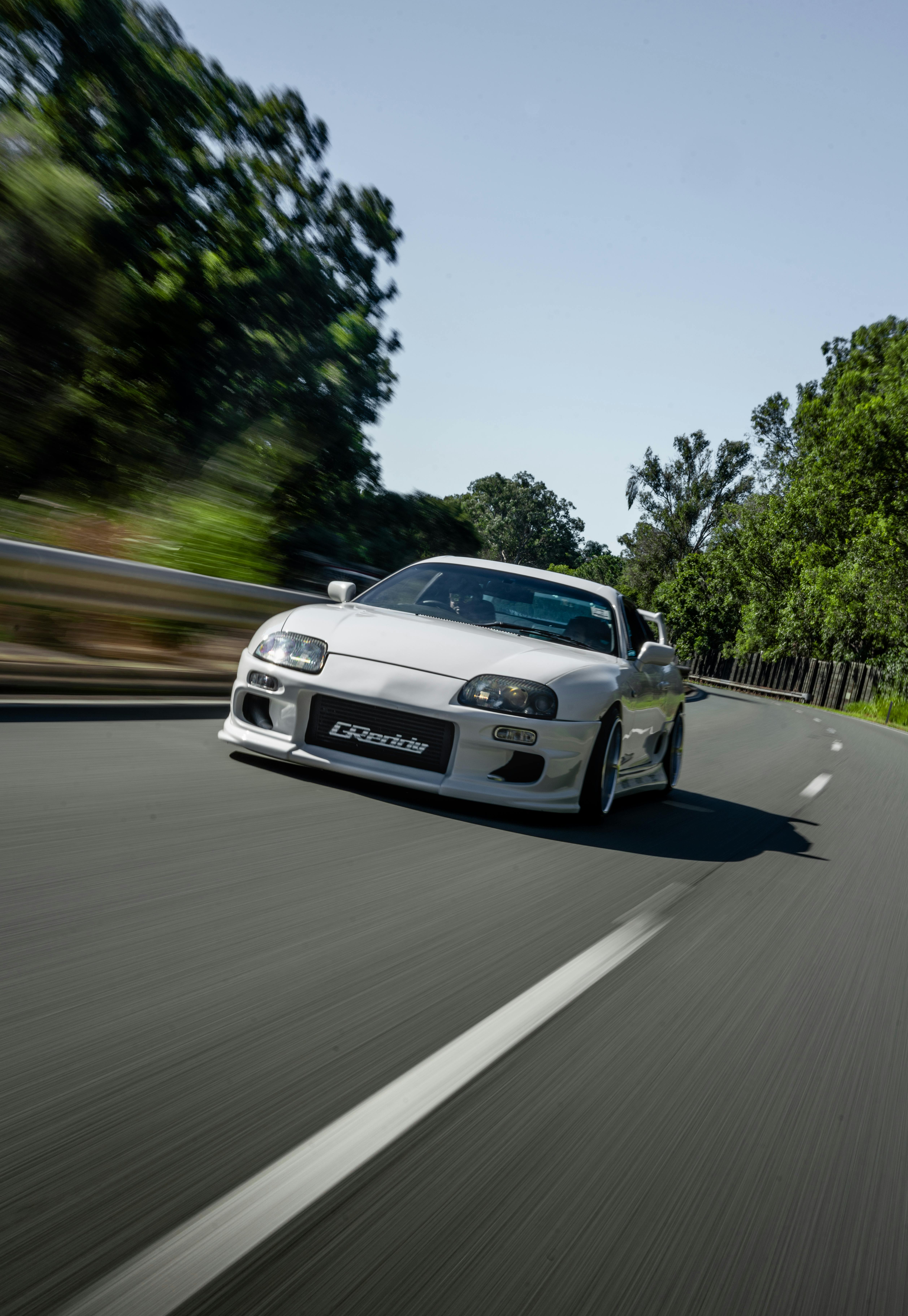 Dynamic Toyota Supra MK4 in Motion on Open Road · Free Stock Photo