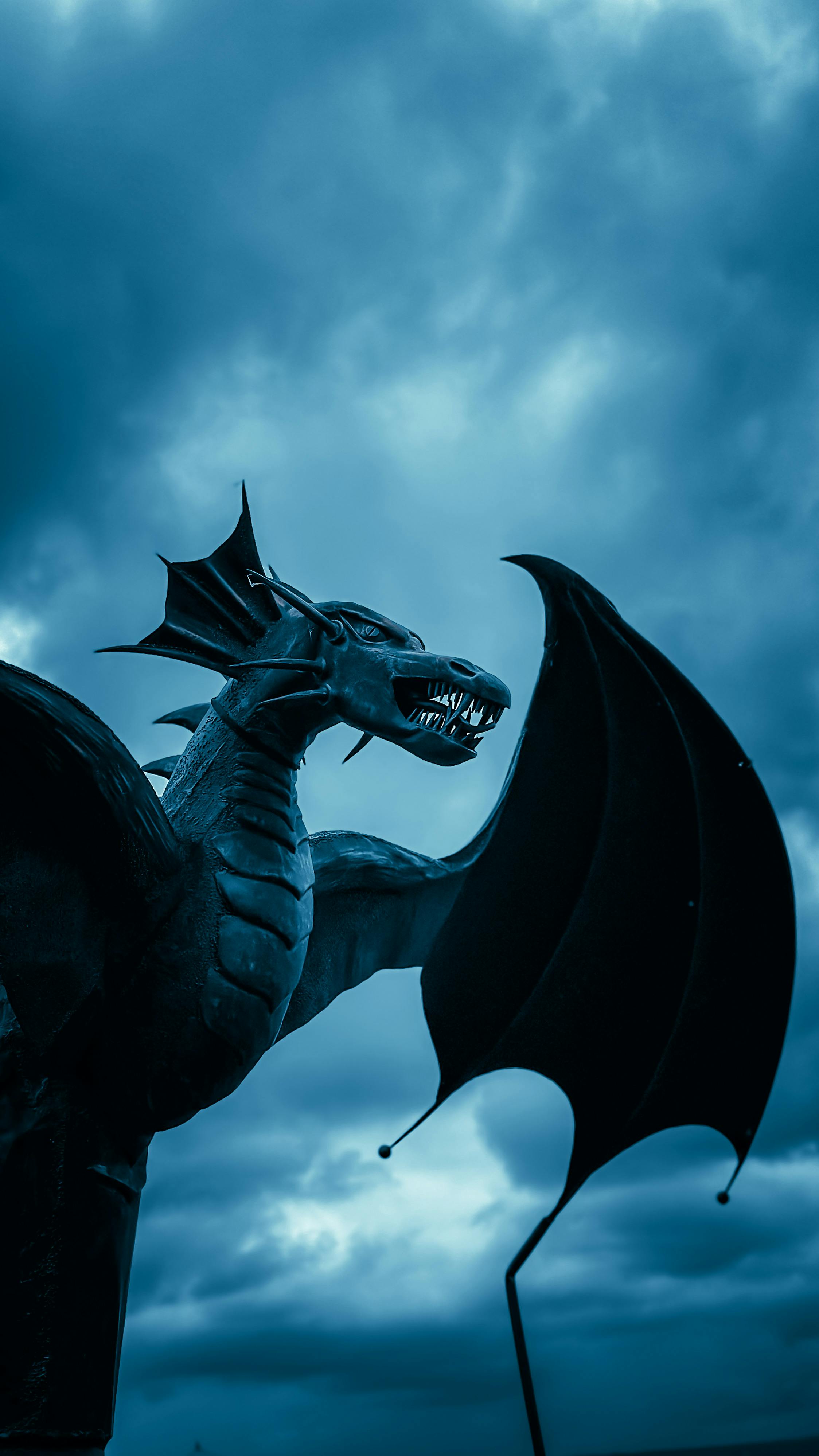 Dramatic Dragon Sculpture Against Cloudy Sky · Free Stock Photo