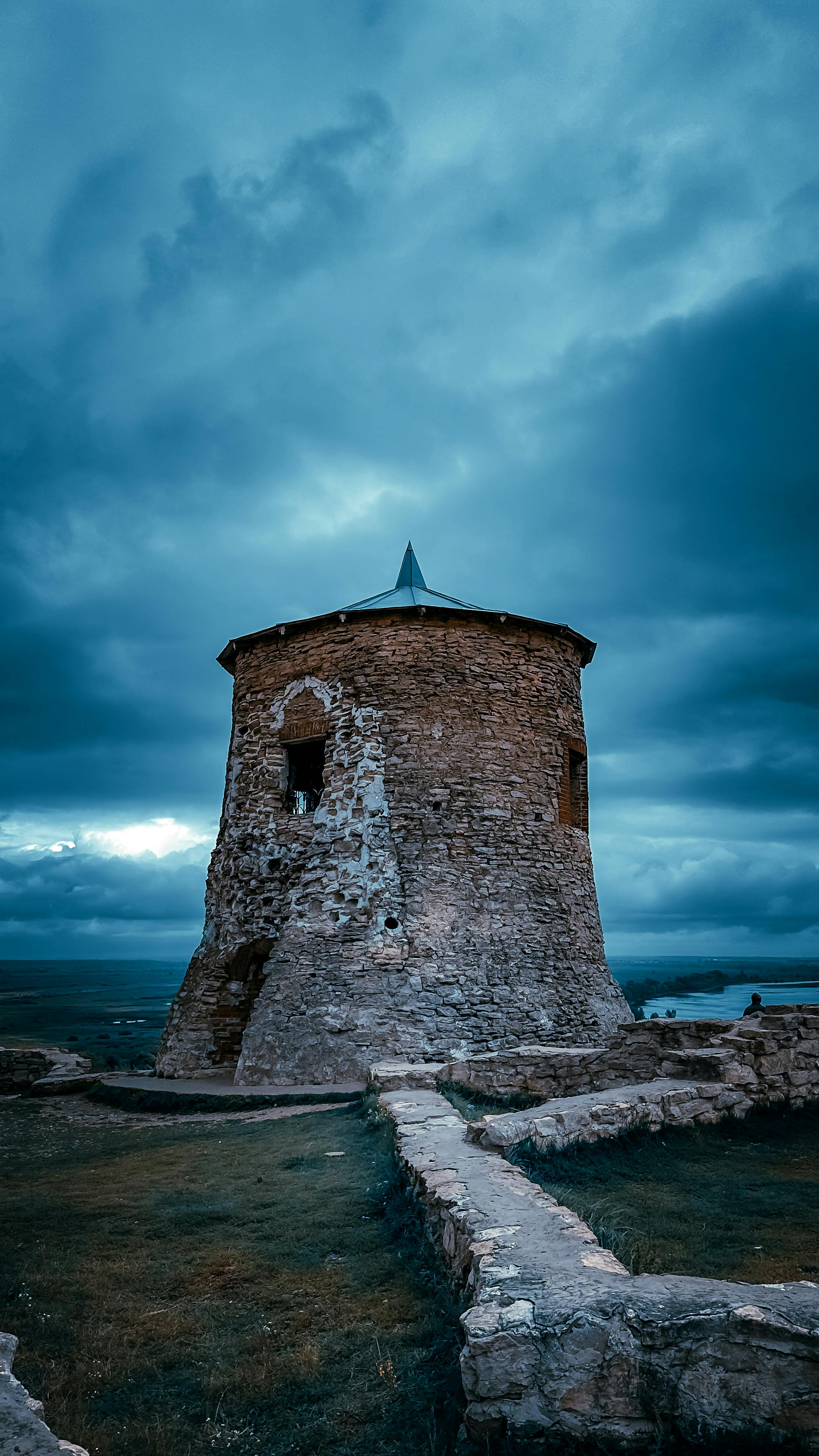 Ancient Stone Tower Against Dramatic Sky · Free Stock Photo