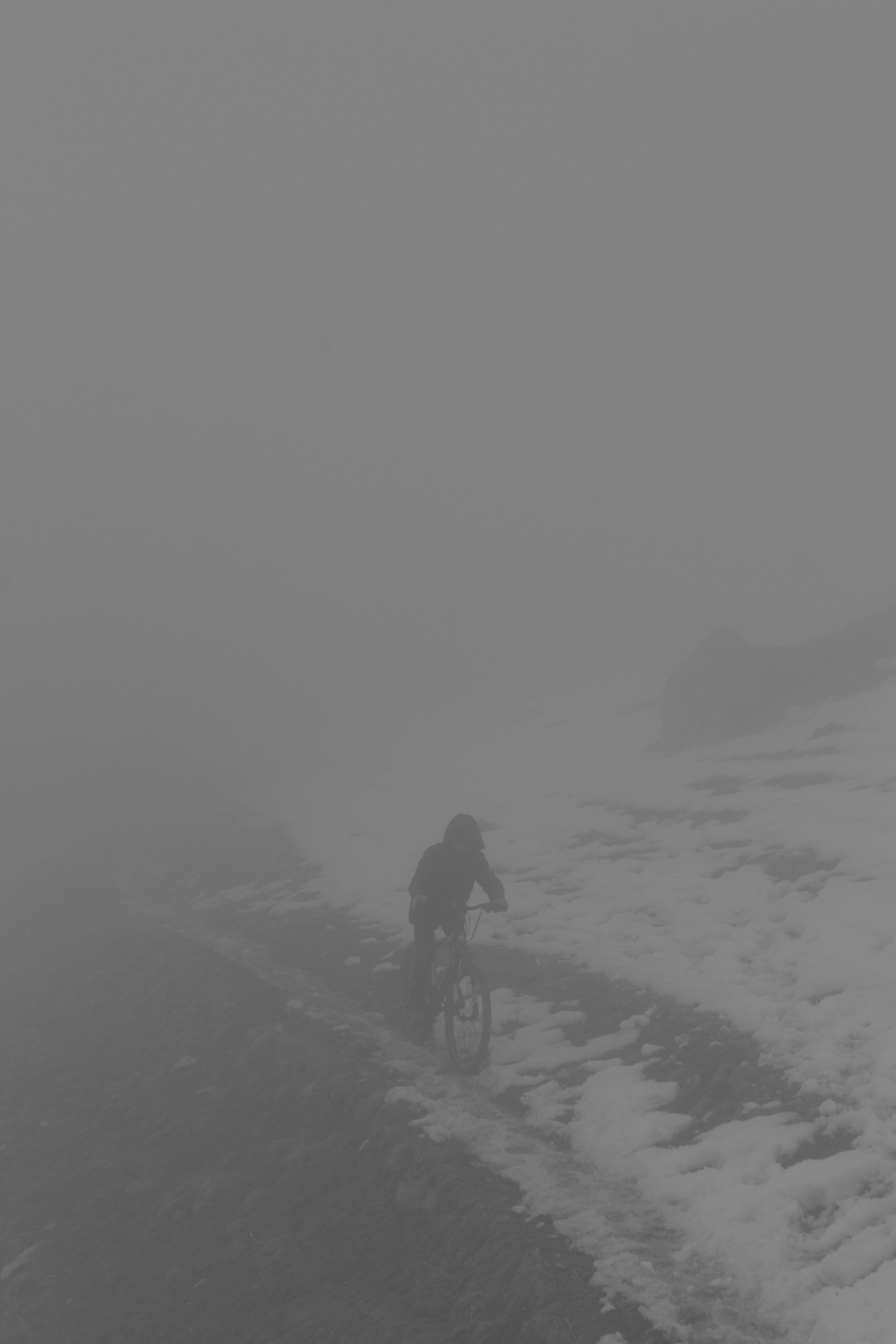 Cyclist Journeys Through Misty Snowy Path · Free Stock Photo