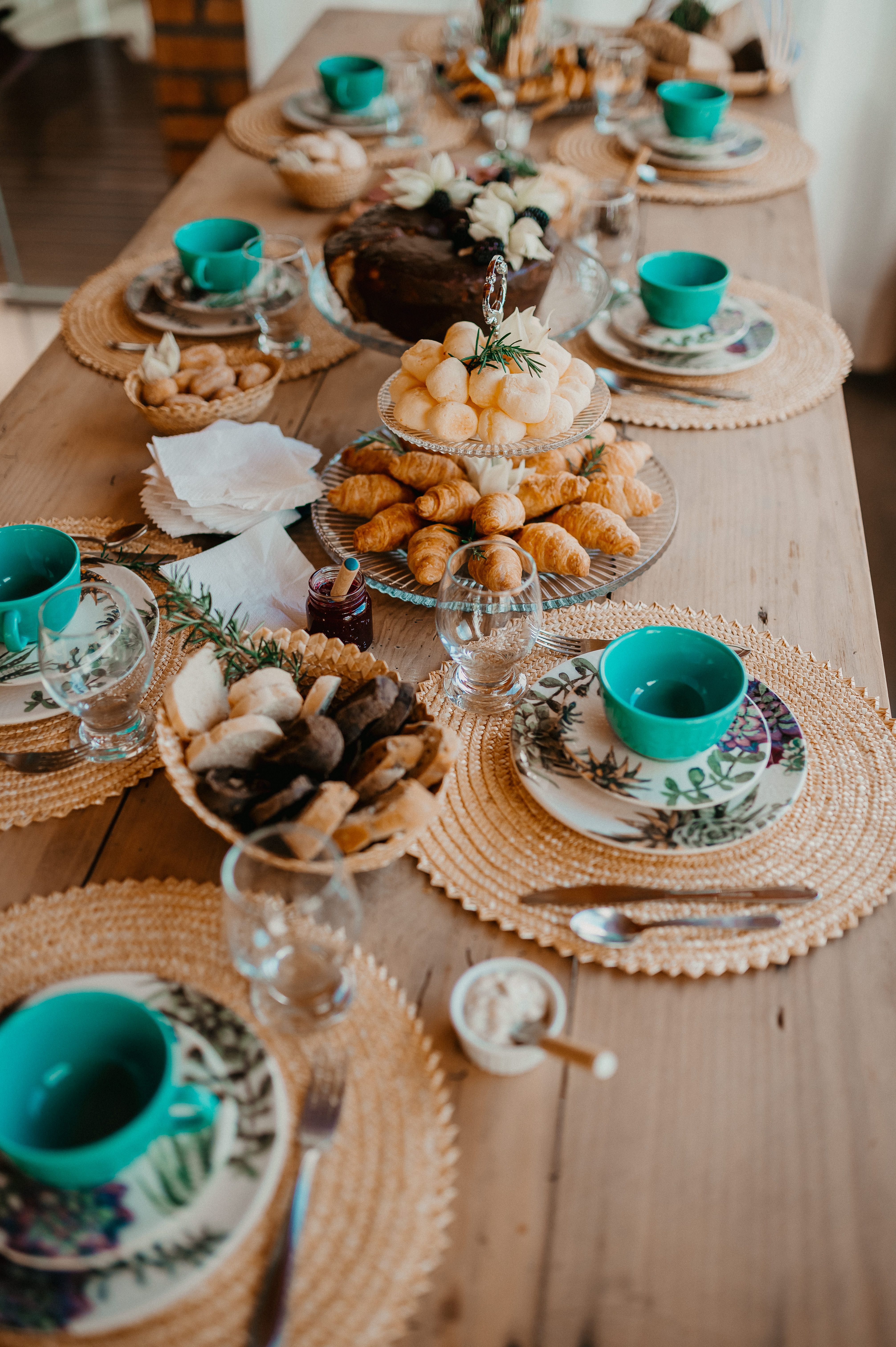 Elegant Brunch Setup with Pastries and Floral Plates · Free Stock Photo