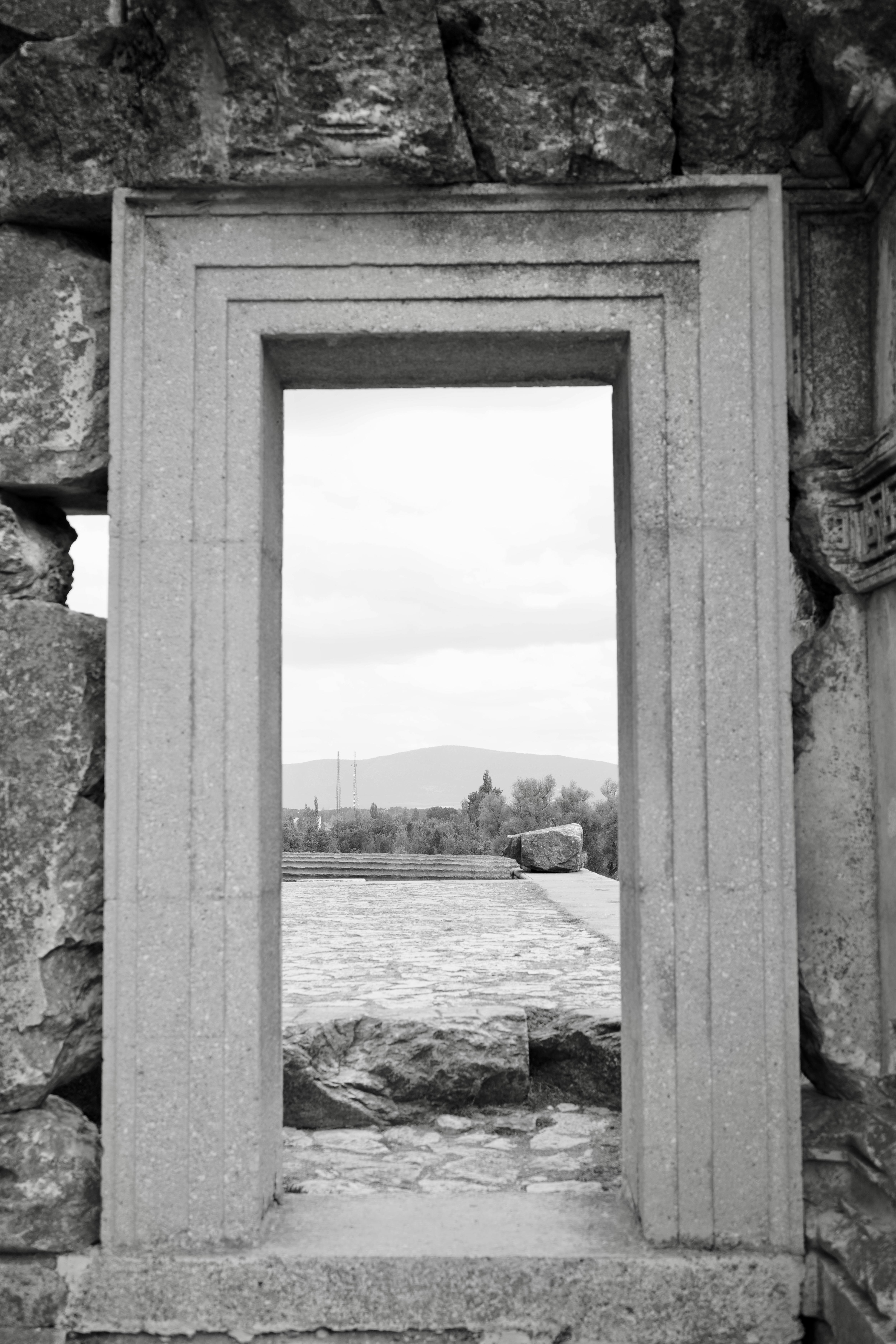 Ancient Stone Window Overlooking Scenic Landscape · Free Stock Photo