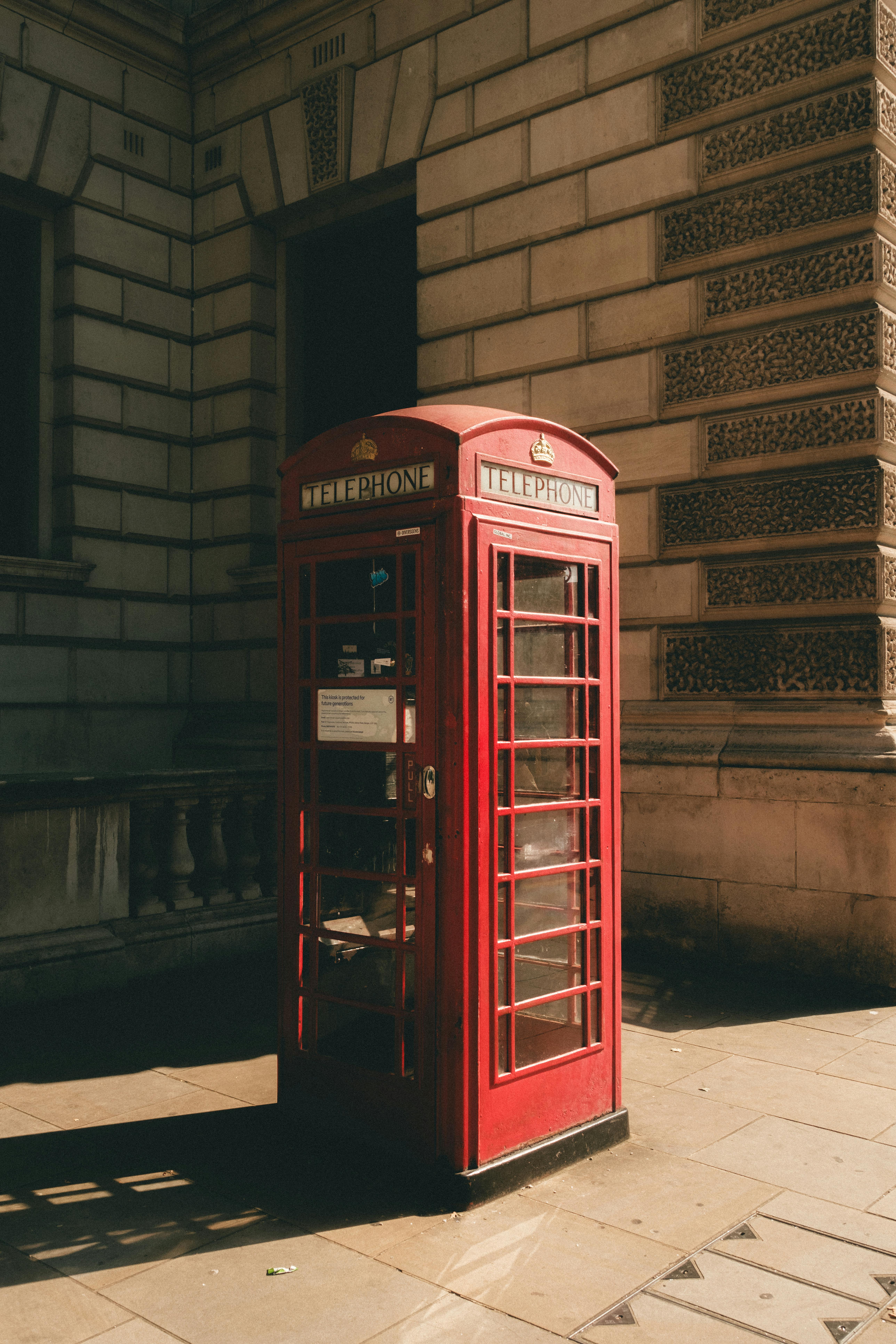 Iconic Red Telephone Box in Urban Setting · Free Stock Photo
