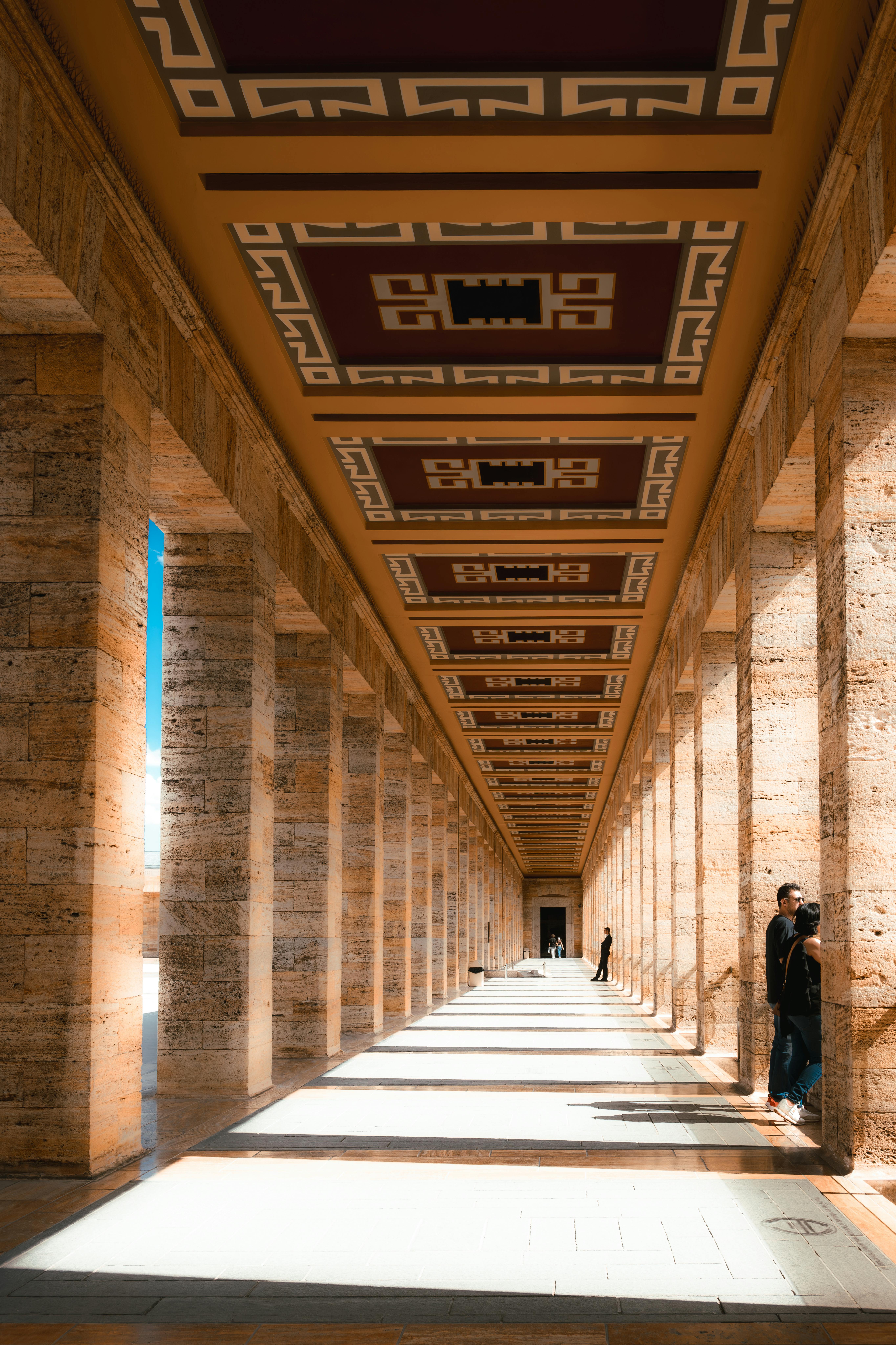 Architectural Corridor with Columns and Patterns · Free Stock Photo