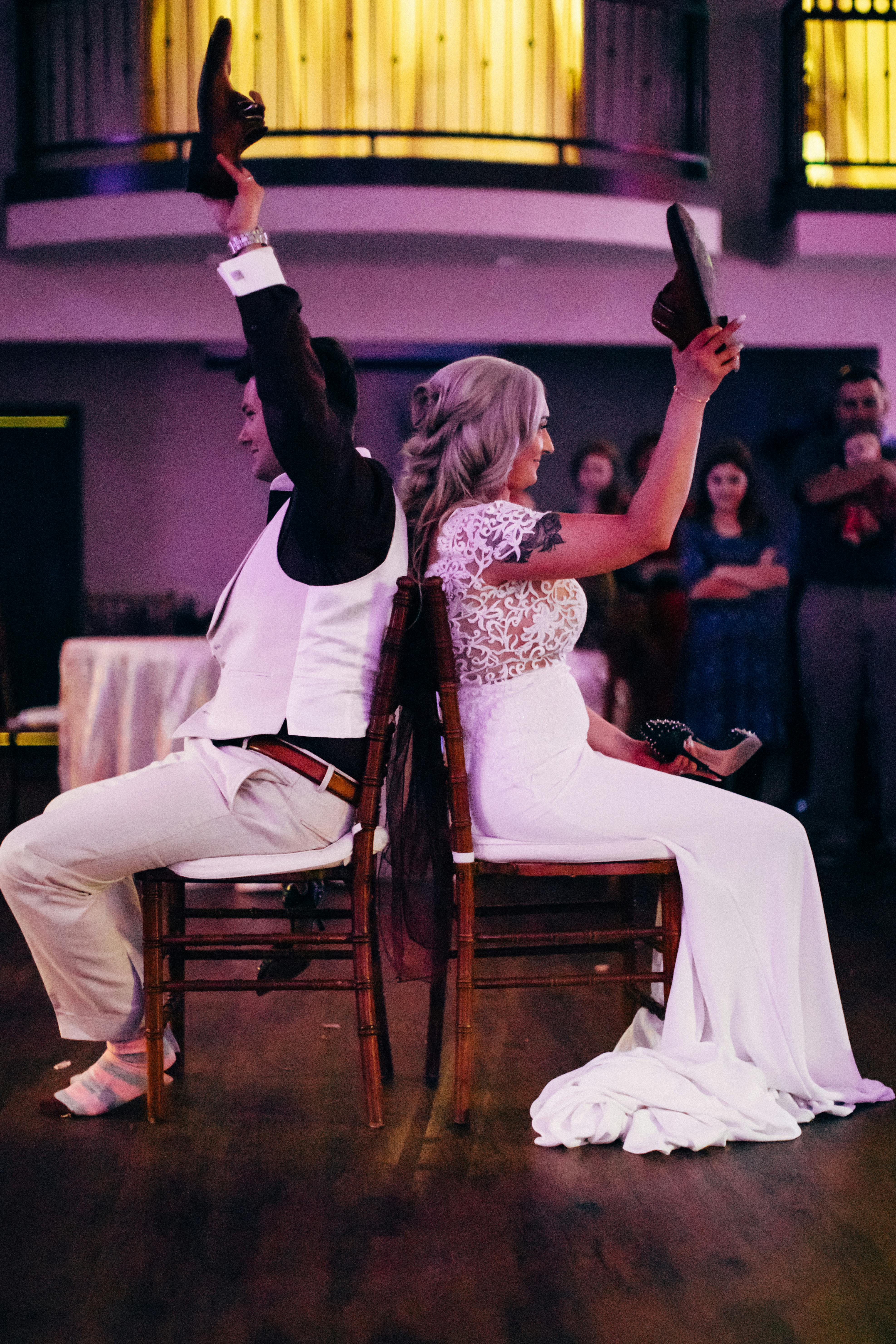 Bride and Groom Playing Wedding Shoe Game indoors · Free Stock Photo