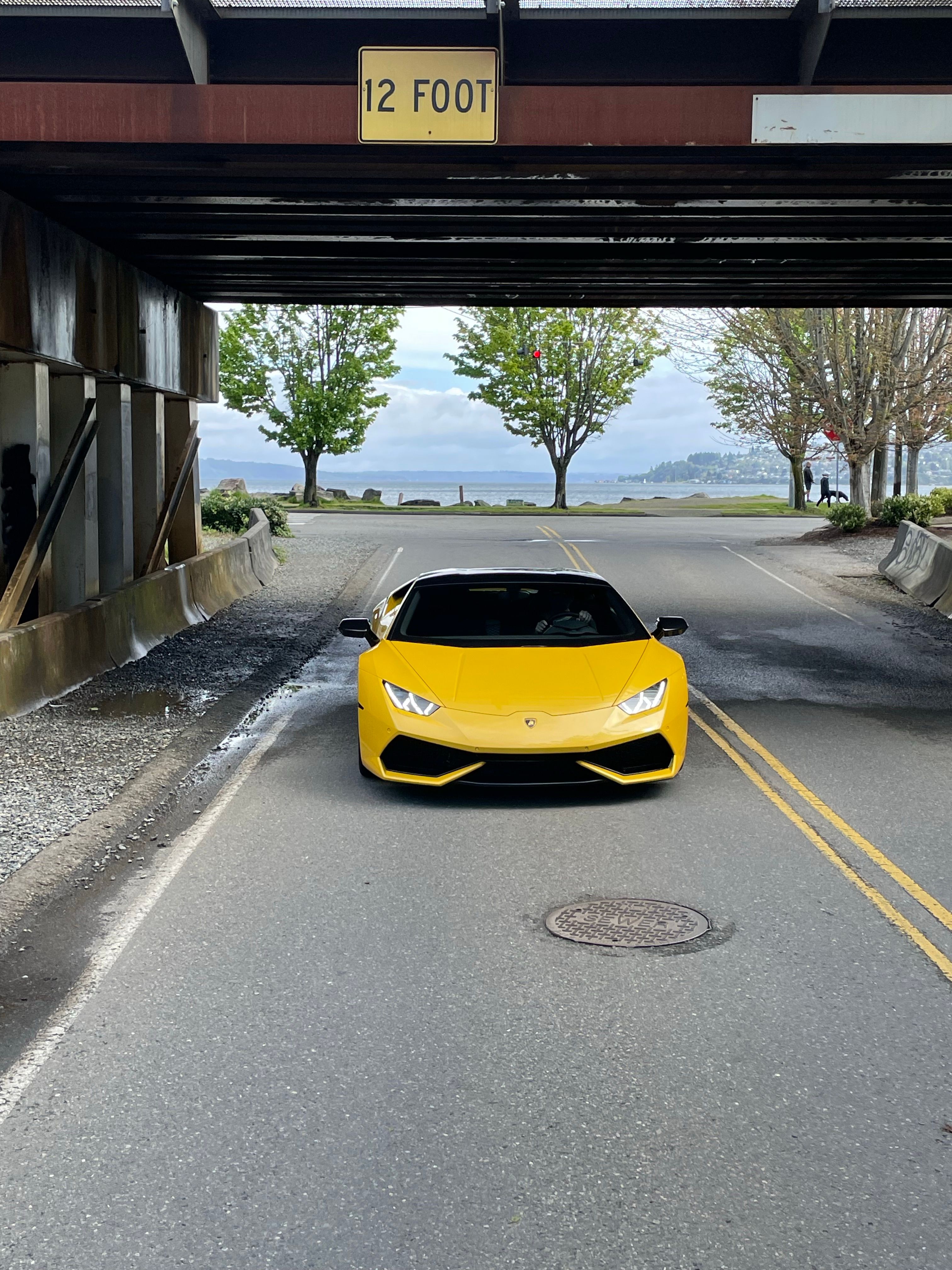 Yellow Sports Car Under Bridge Scenic View · Free Stock Photo