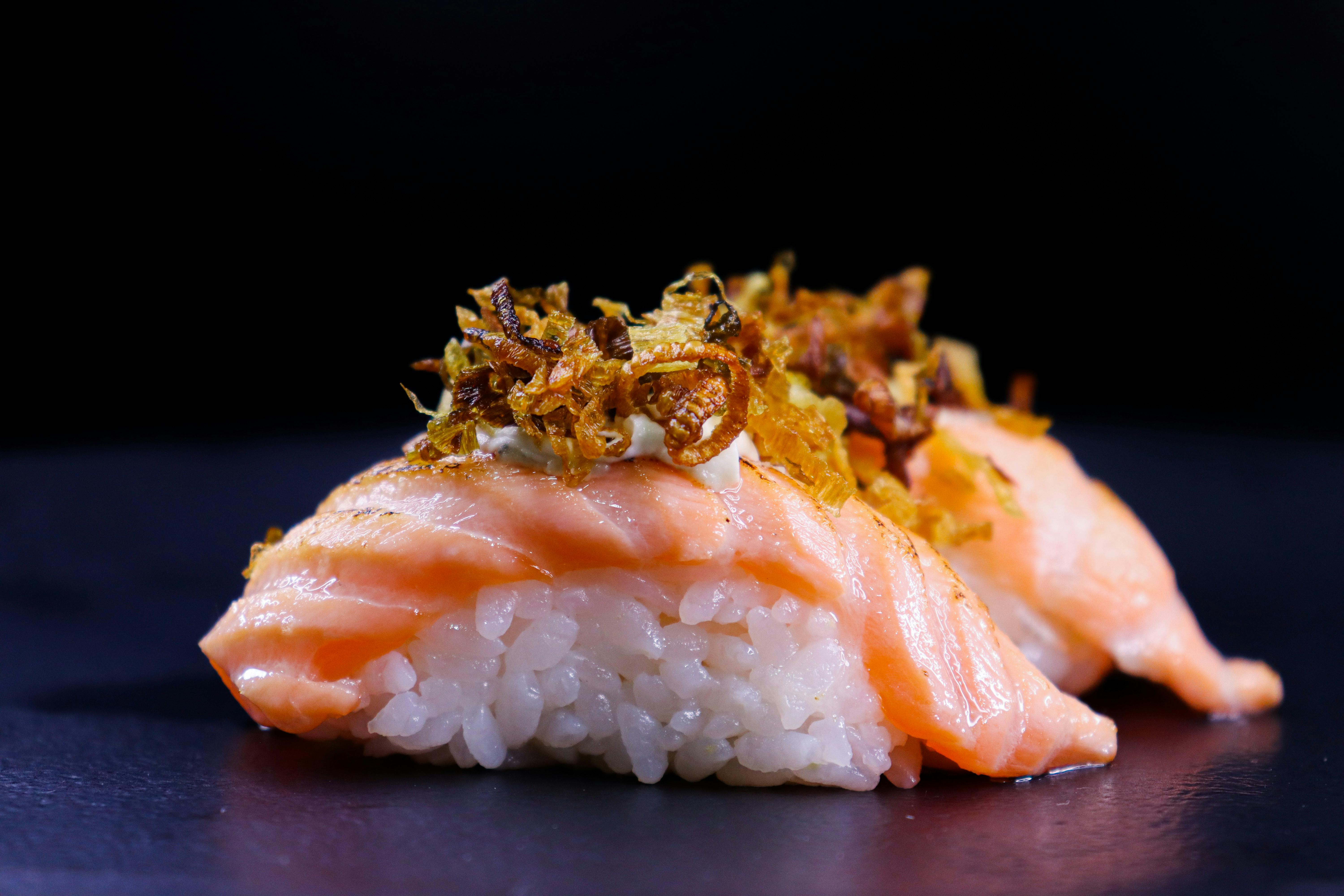 Close-up of Salmon Sushi with Crispy Fried Onions · Free Stock Photo