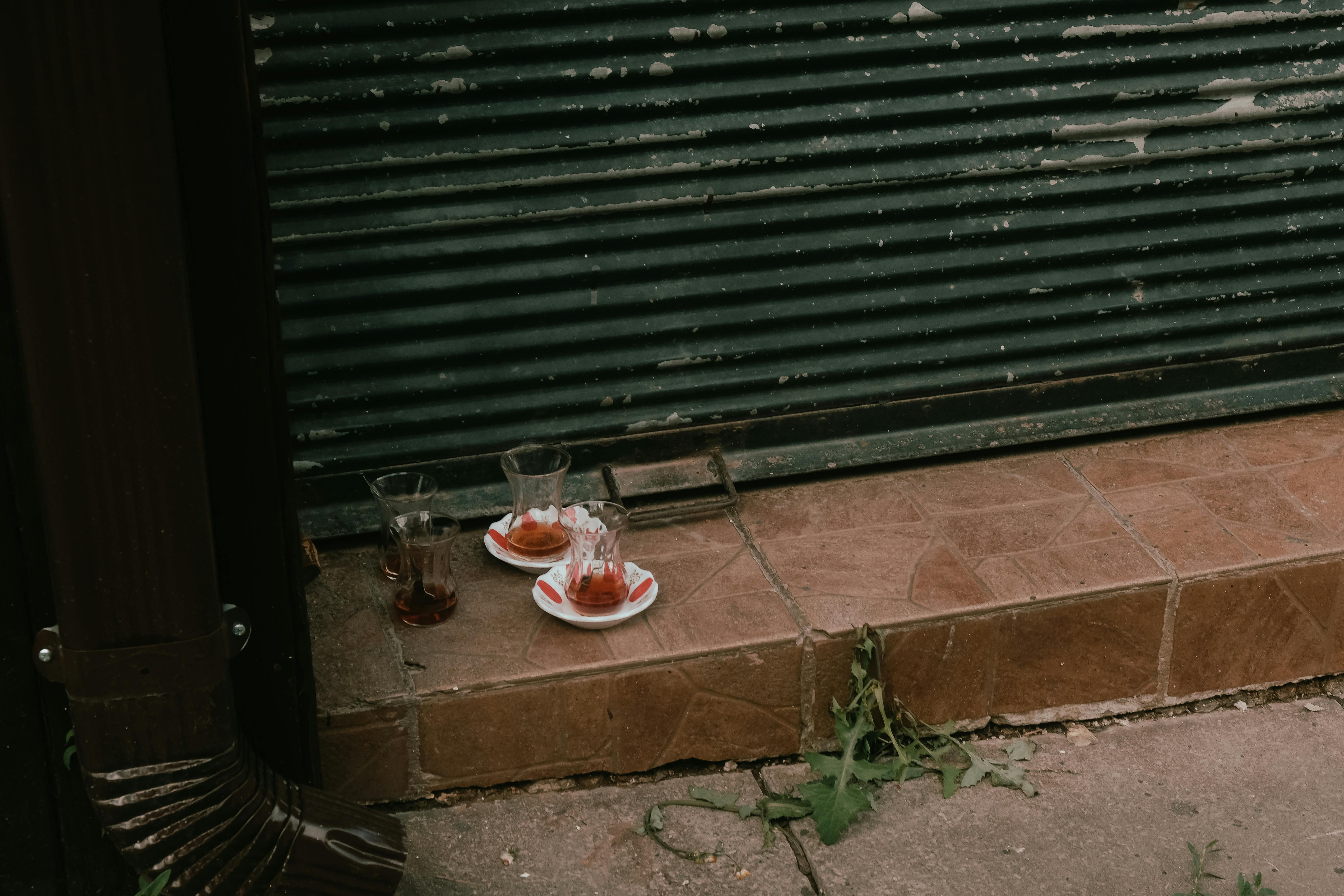 Urban Scene with Abandoned Tea Glasses on a Step · Free Stock Photo