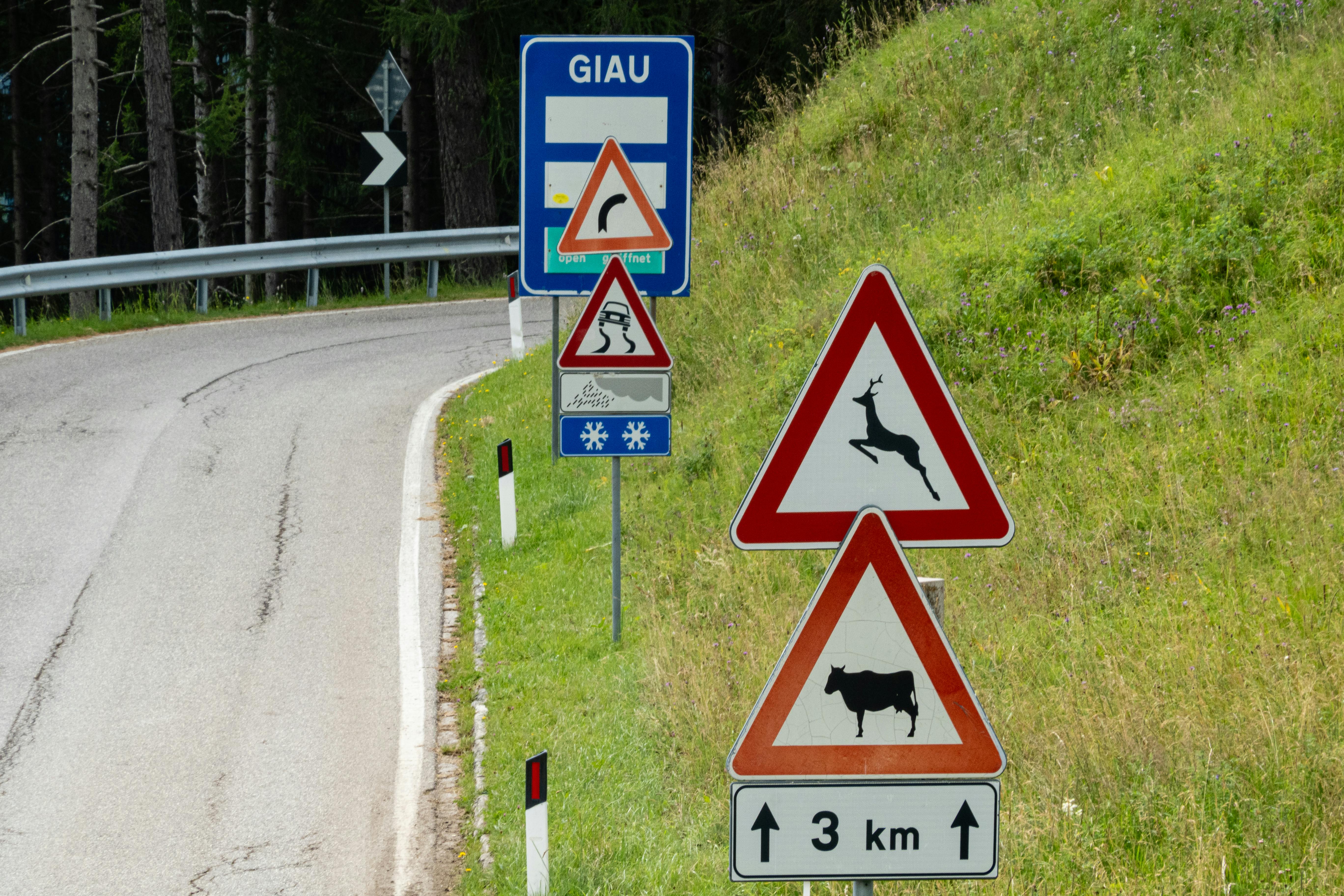 Road Signs on Mountainous Curve in Giau Pass · Free Stock Photo