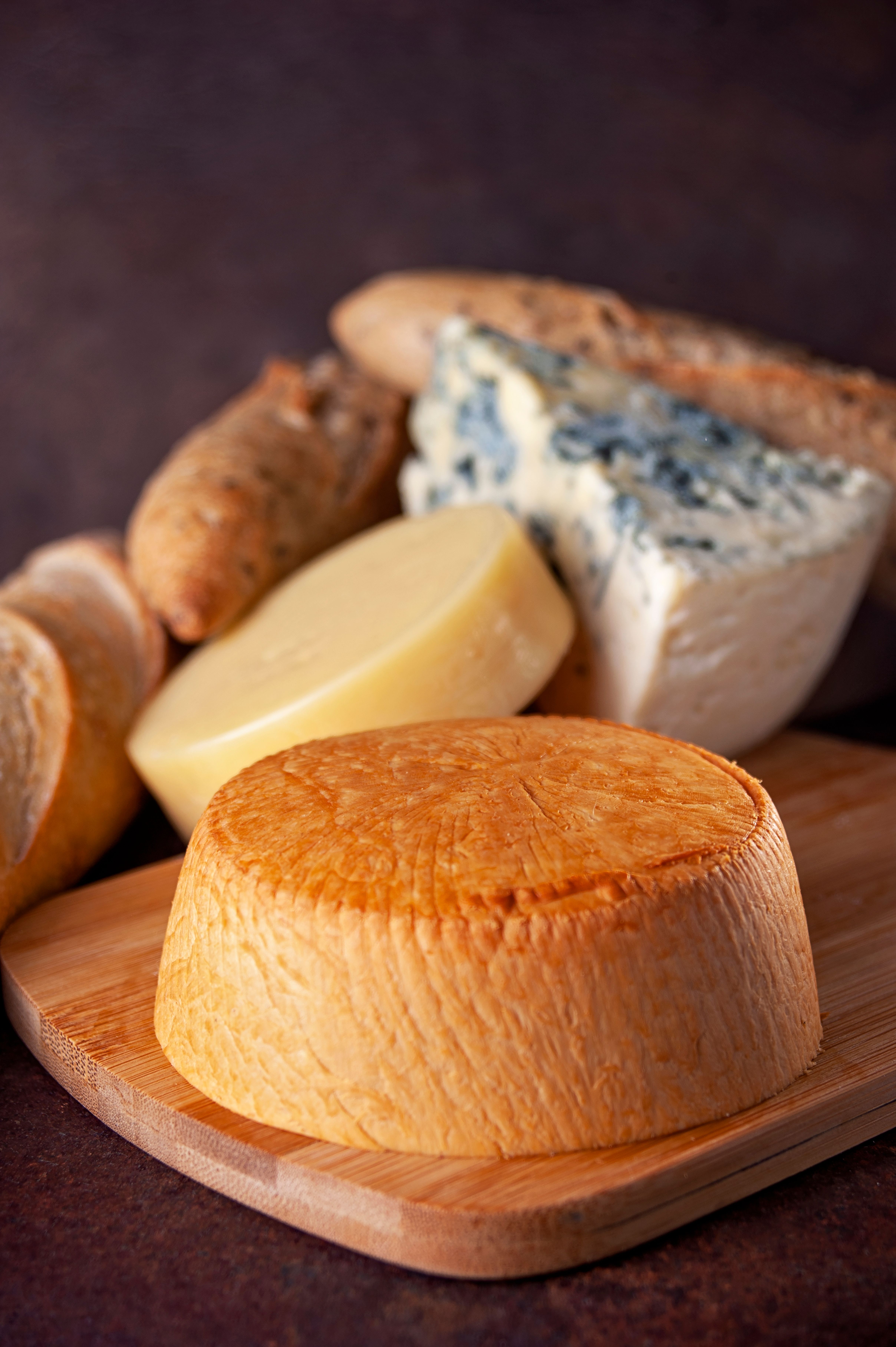 Artisanal Cheese and Bread on Wooden Board · Free Stock Photo