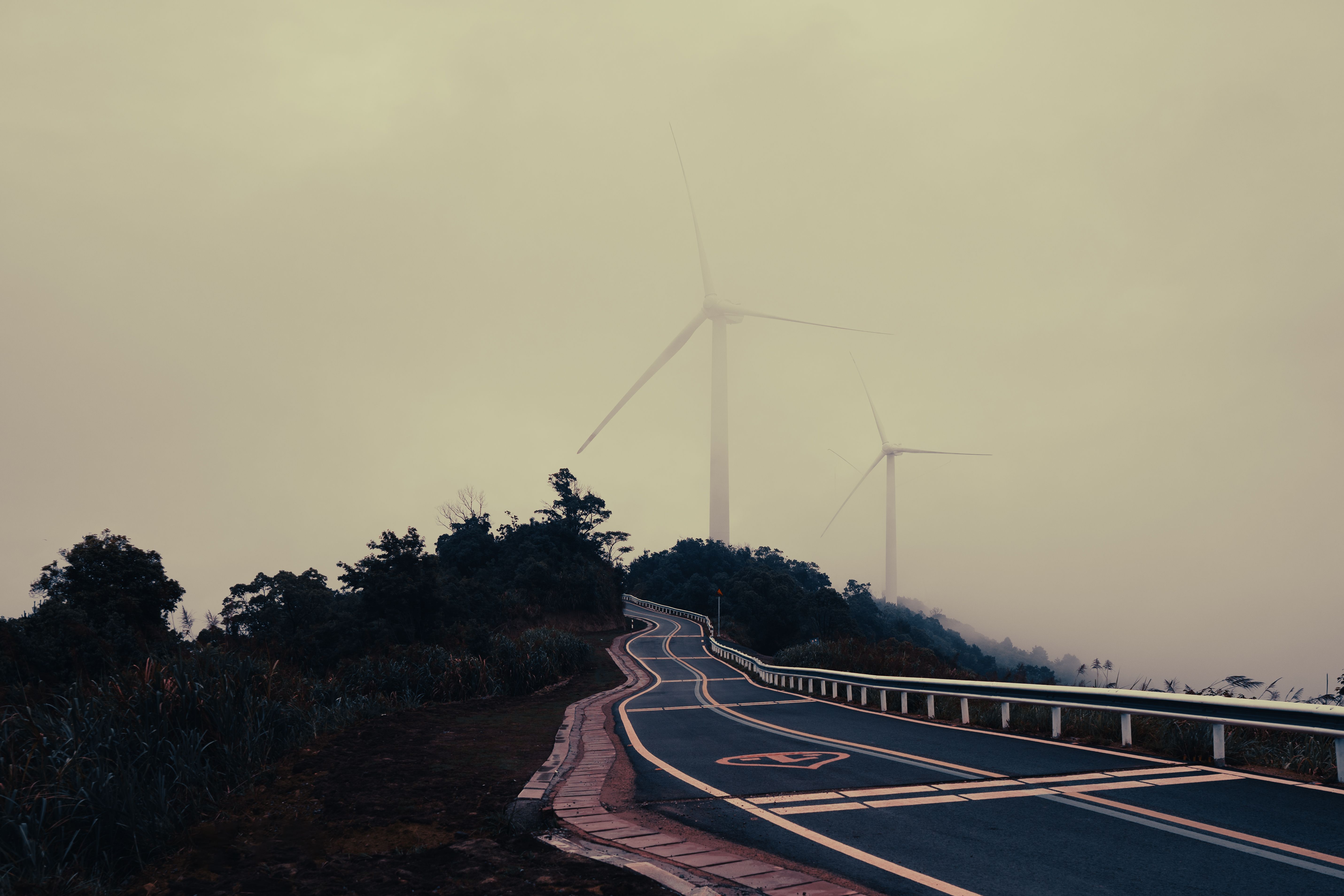 Foggy Road Leading to Wind Turbines · Free Stock Photo