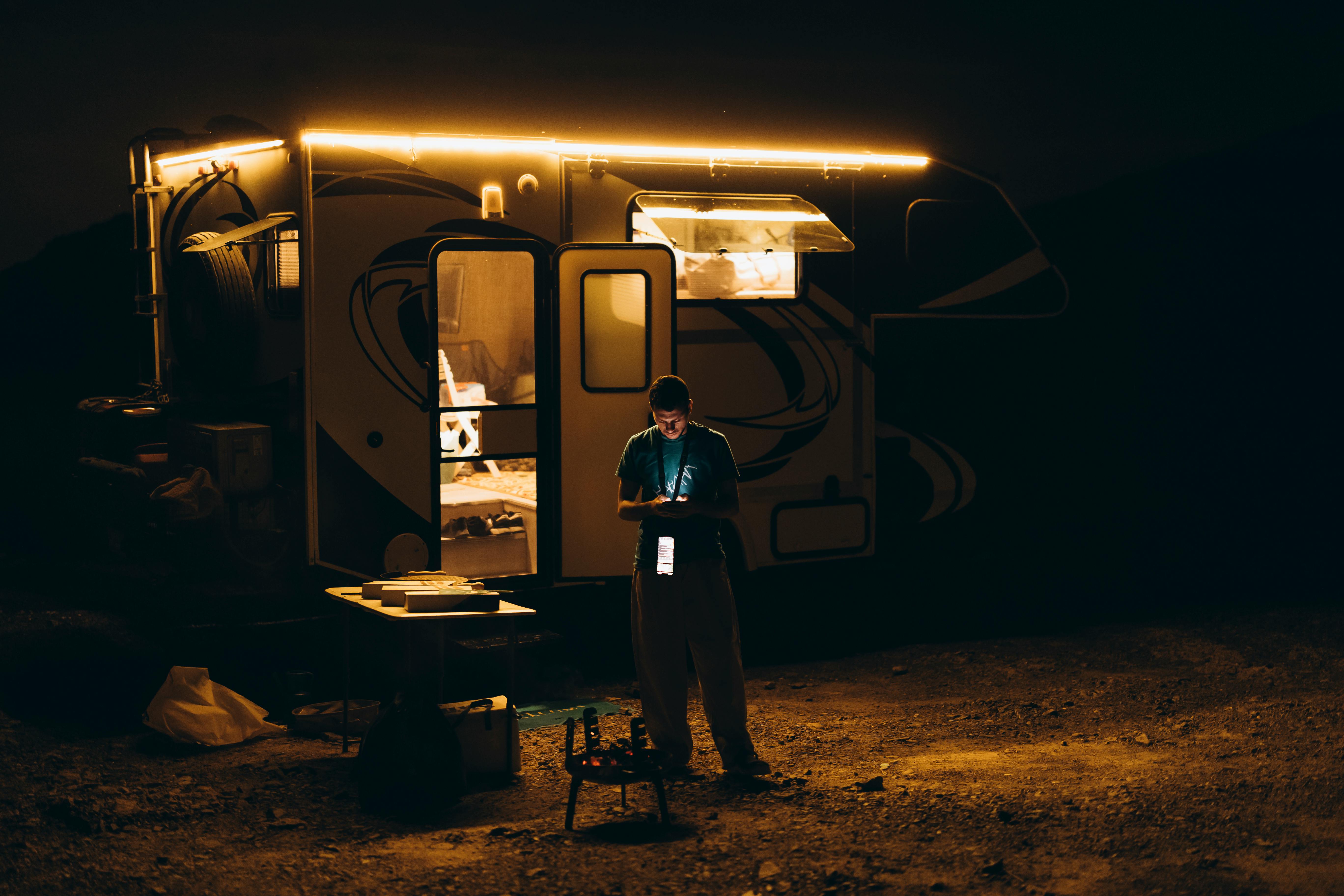 Night Camping Scene with Illuminated Caravan · Free Stock Photo