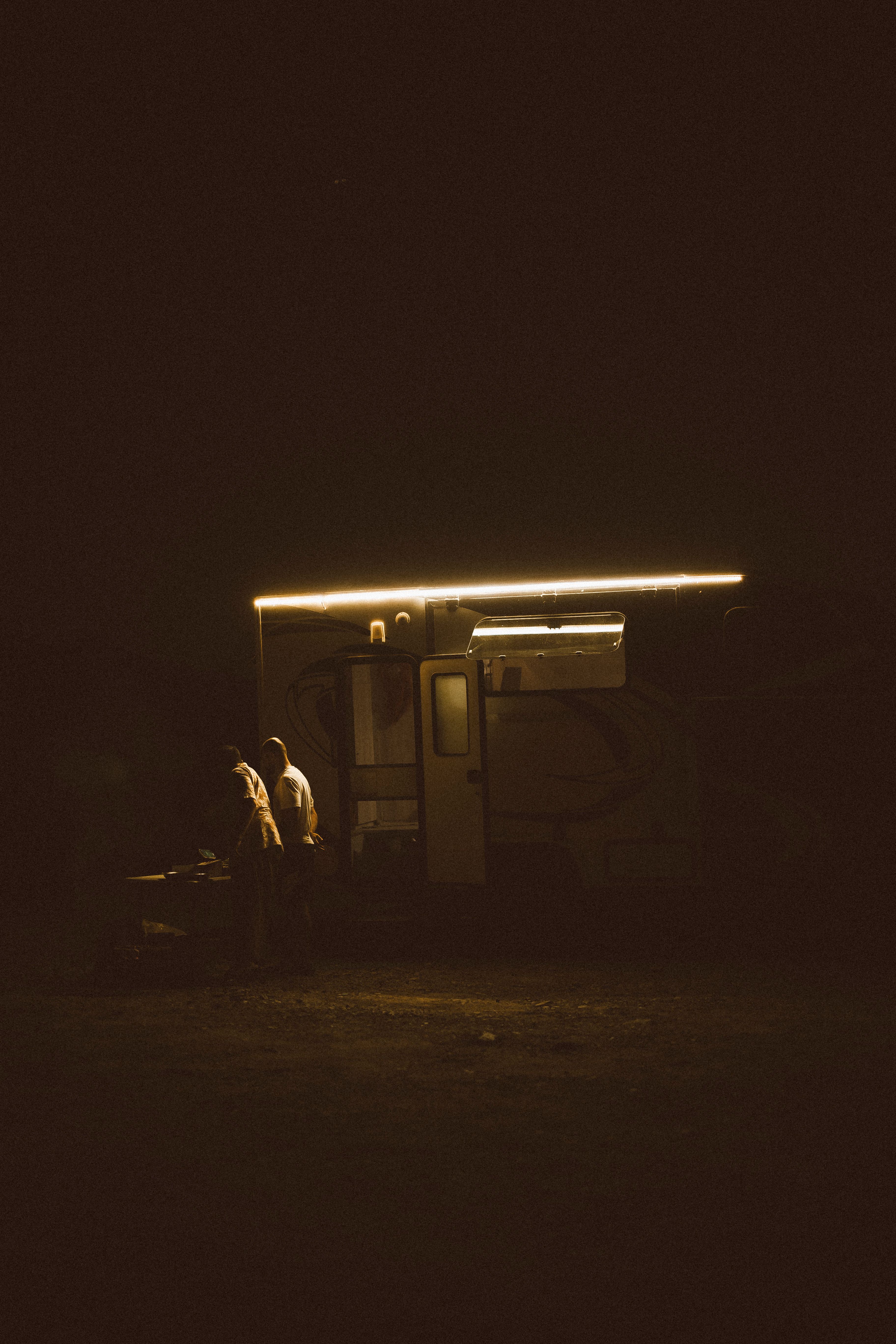 Night Camping Scene with Illuminated RV · Free Stock Photo