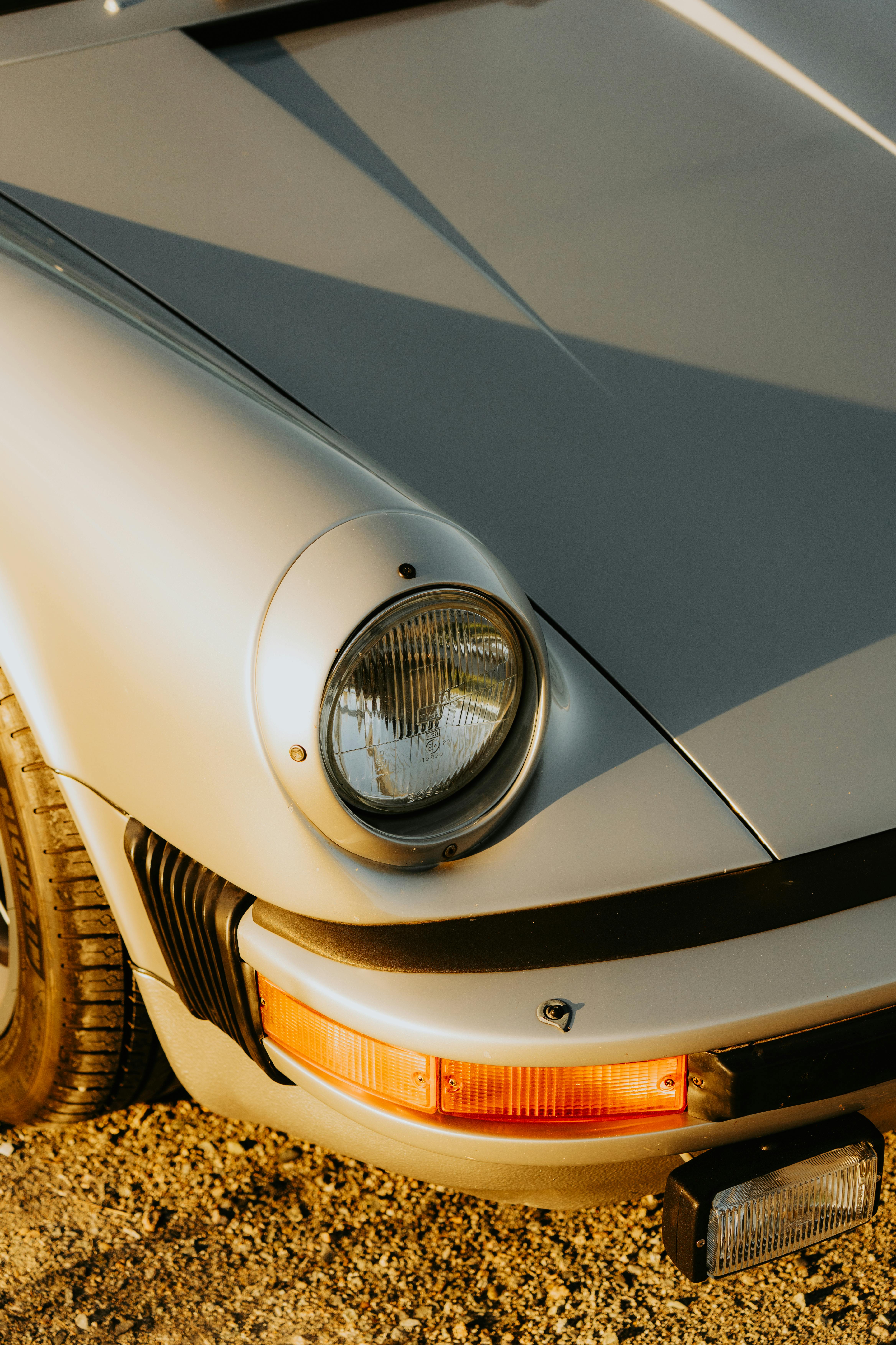 Classic Silver Sports Car in Golden Hour Lighting · Free Stock Photo