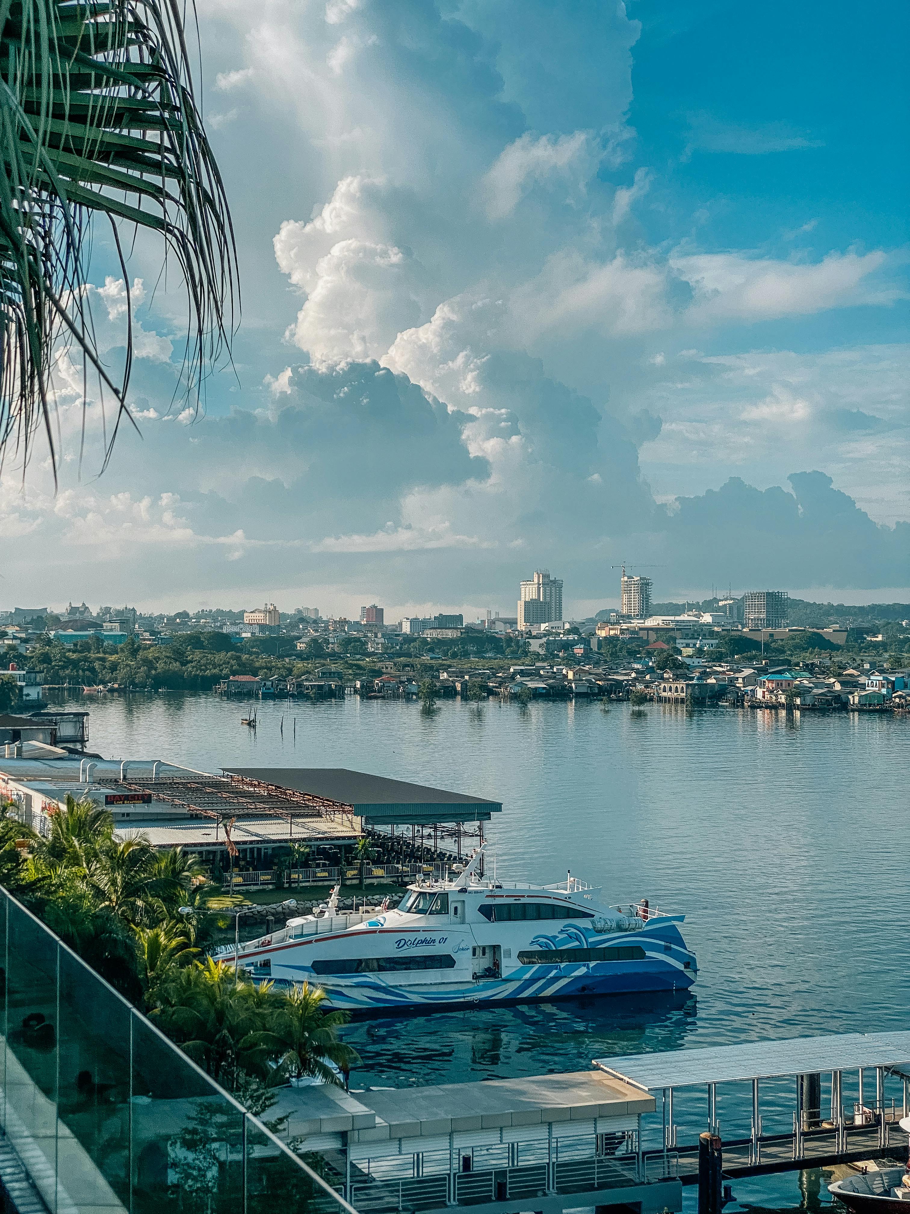 Scenic Waterfront View with Docked Boat · Free Stock Photo