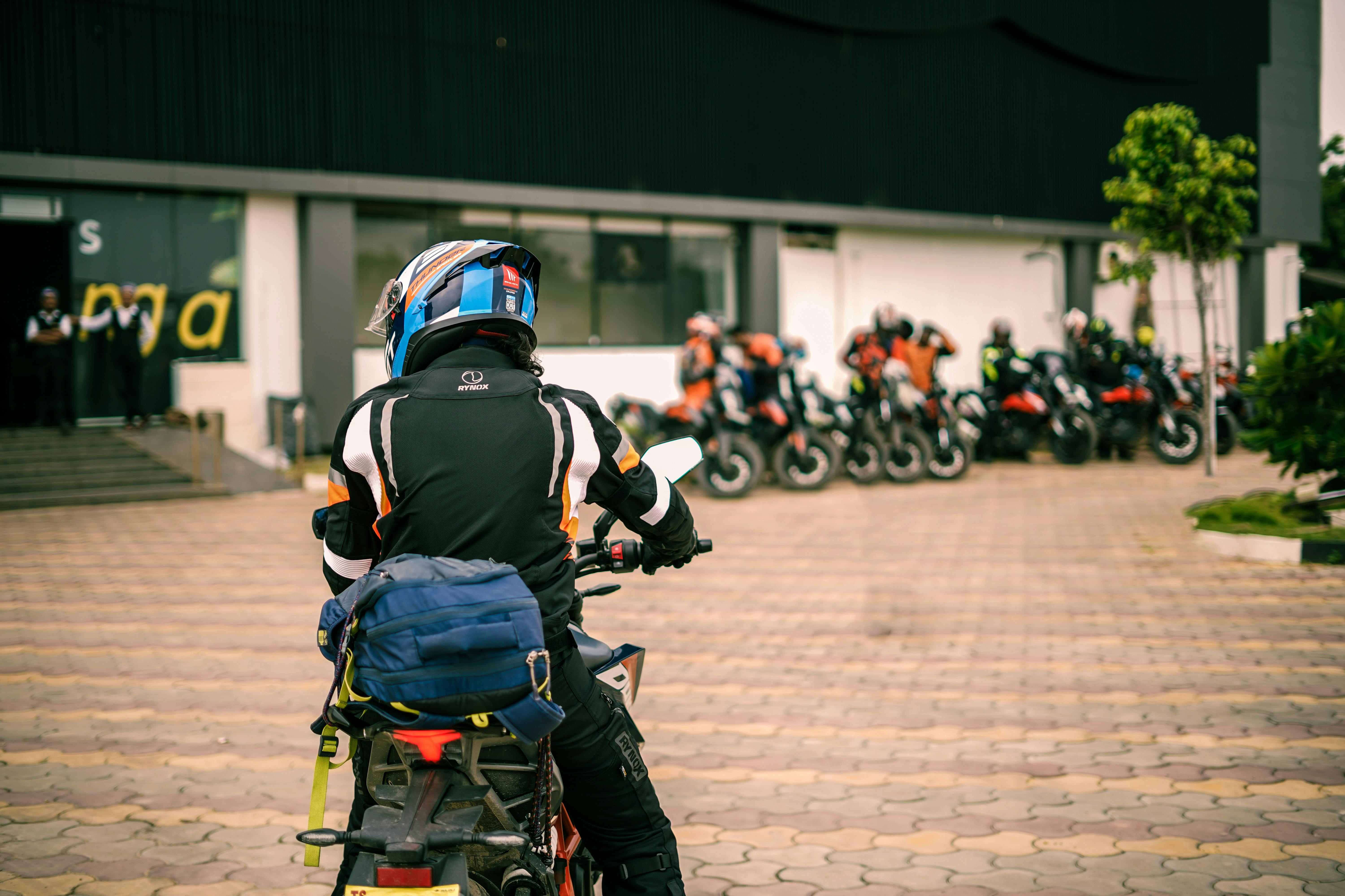 Motorcyclist Approaching Adventure Group · Free Stock Photo