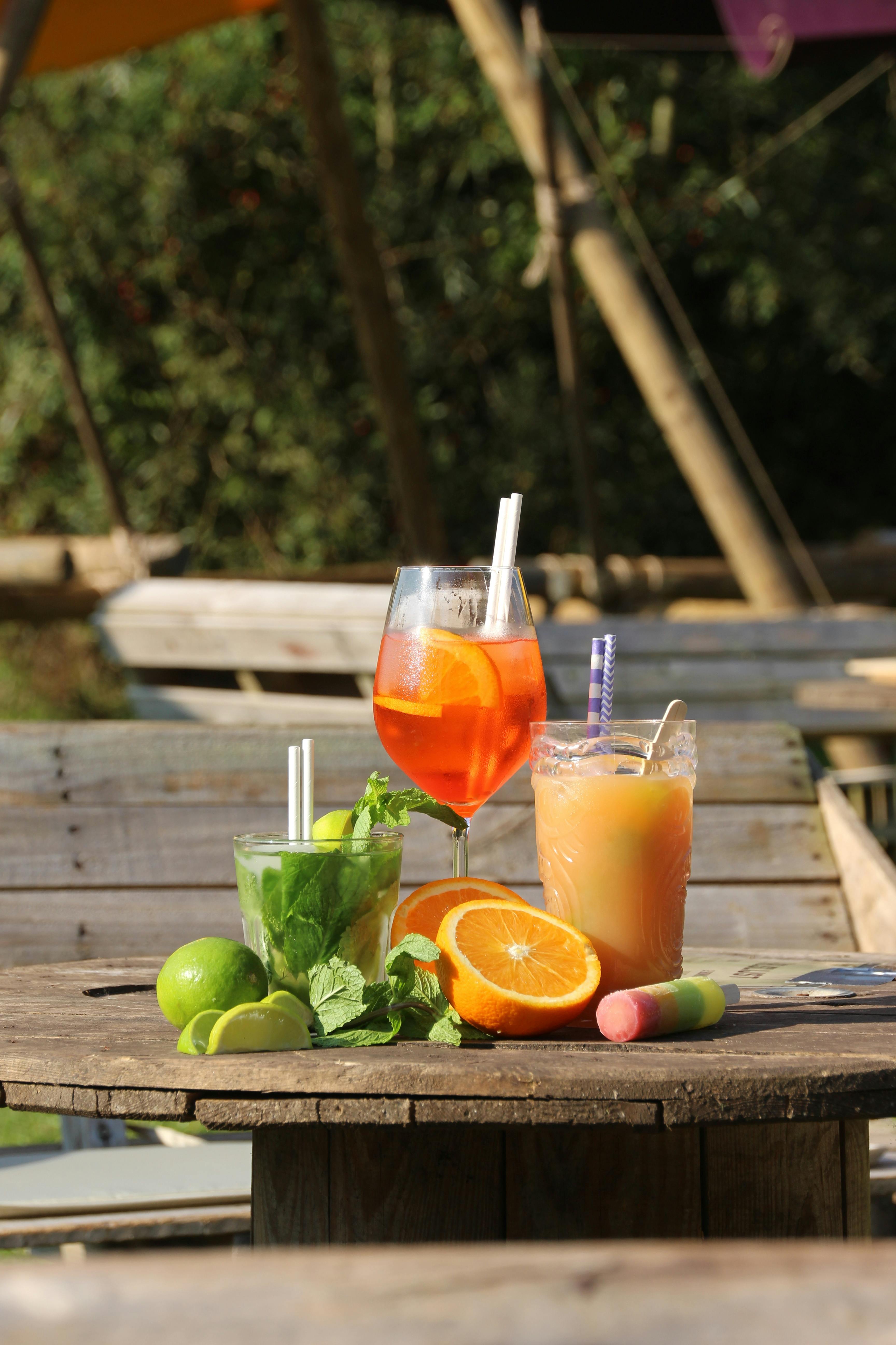 Refreshing Summer Cocktails on Outdoor Table · Free Stock Photo