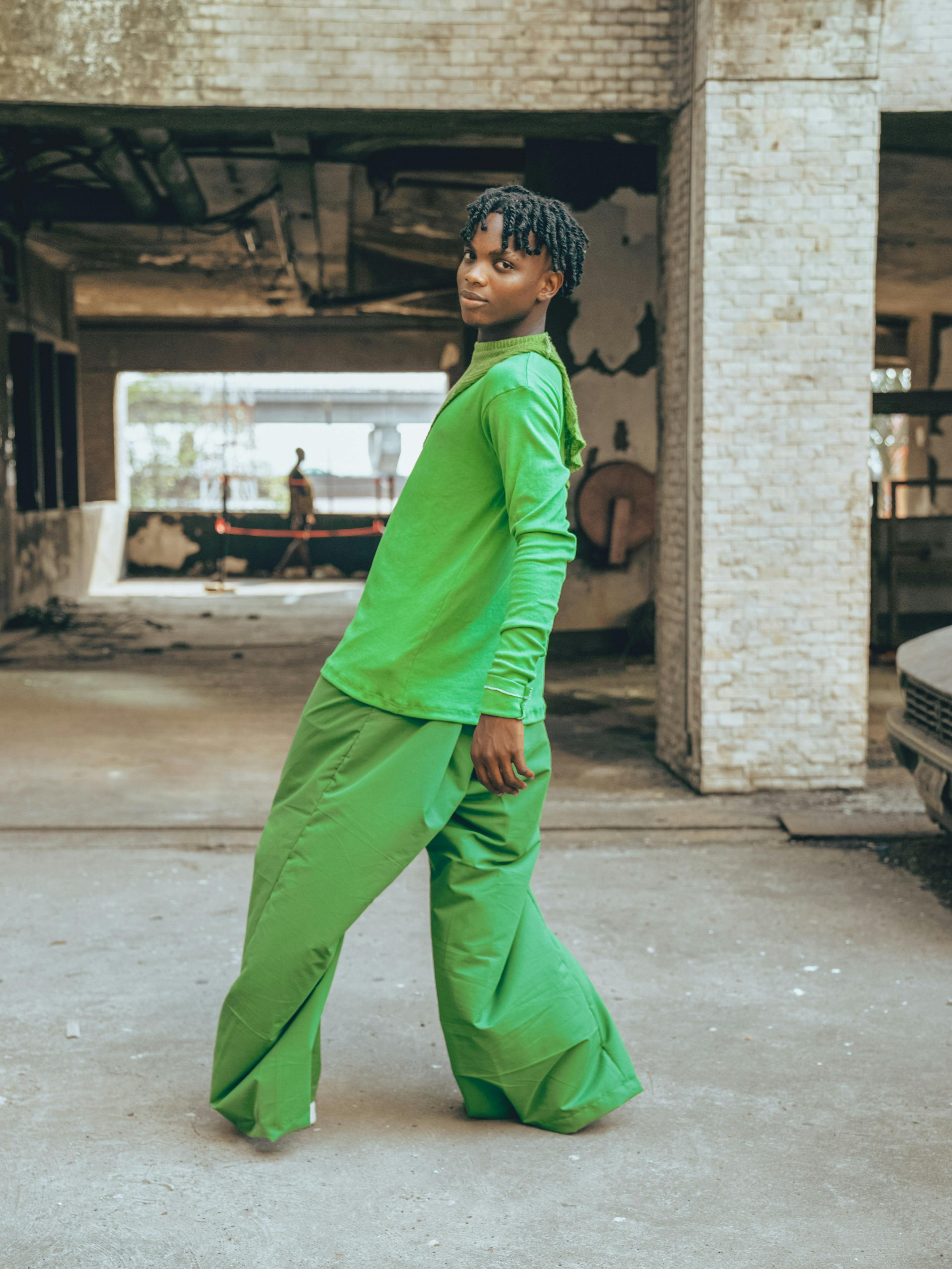 Fashionable Individual in Green Outfit in Urban Setting · Free Stock Photo