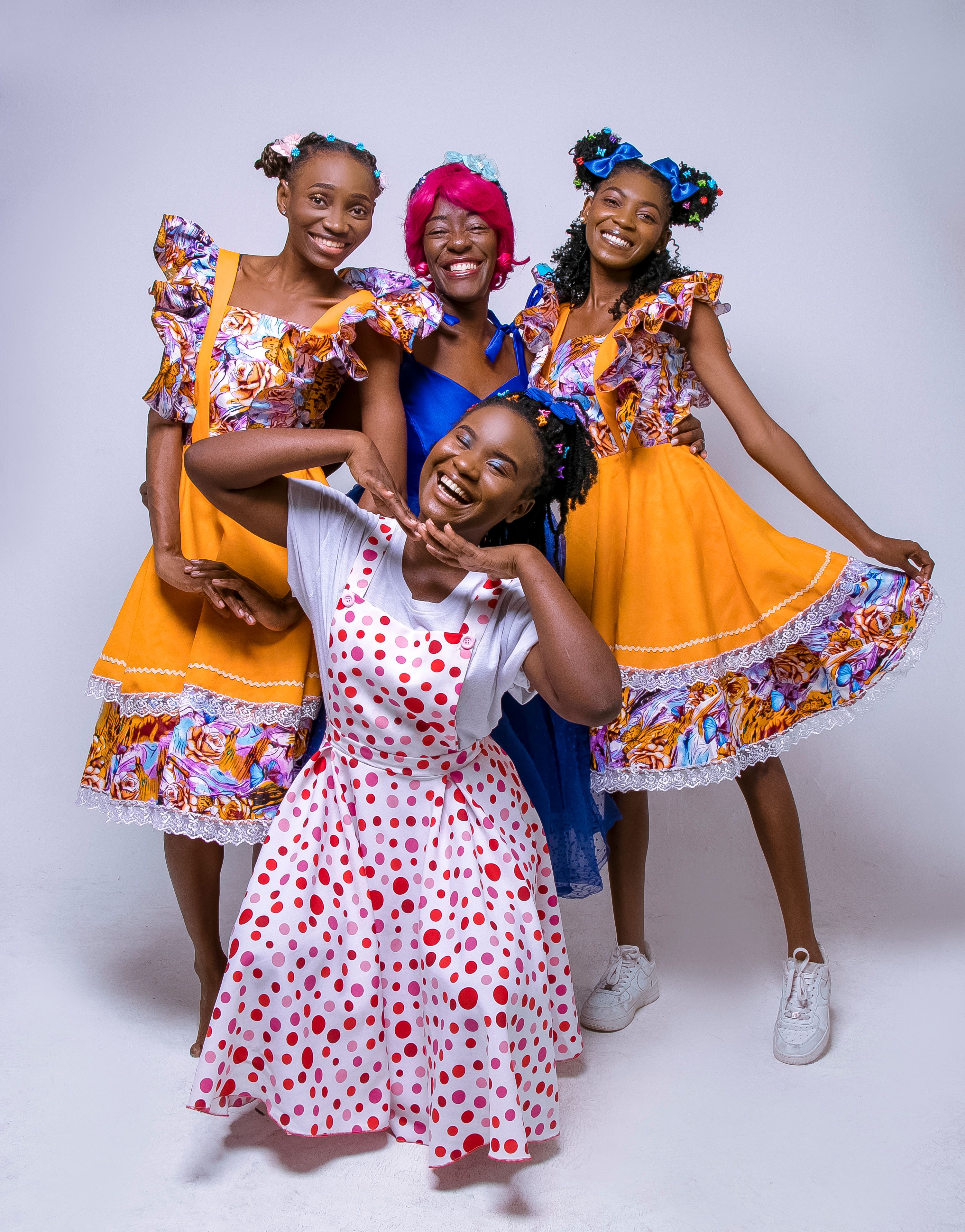 Joyful Group of Women in Colorful Dresses · Free Stock Photo