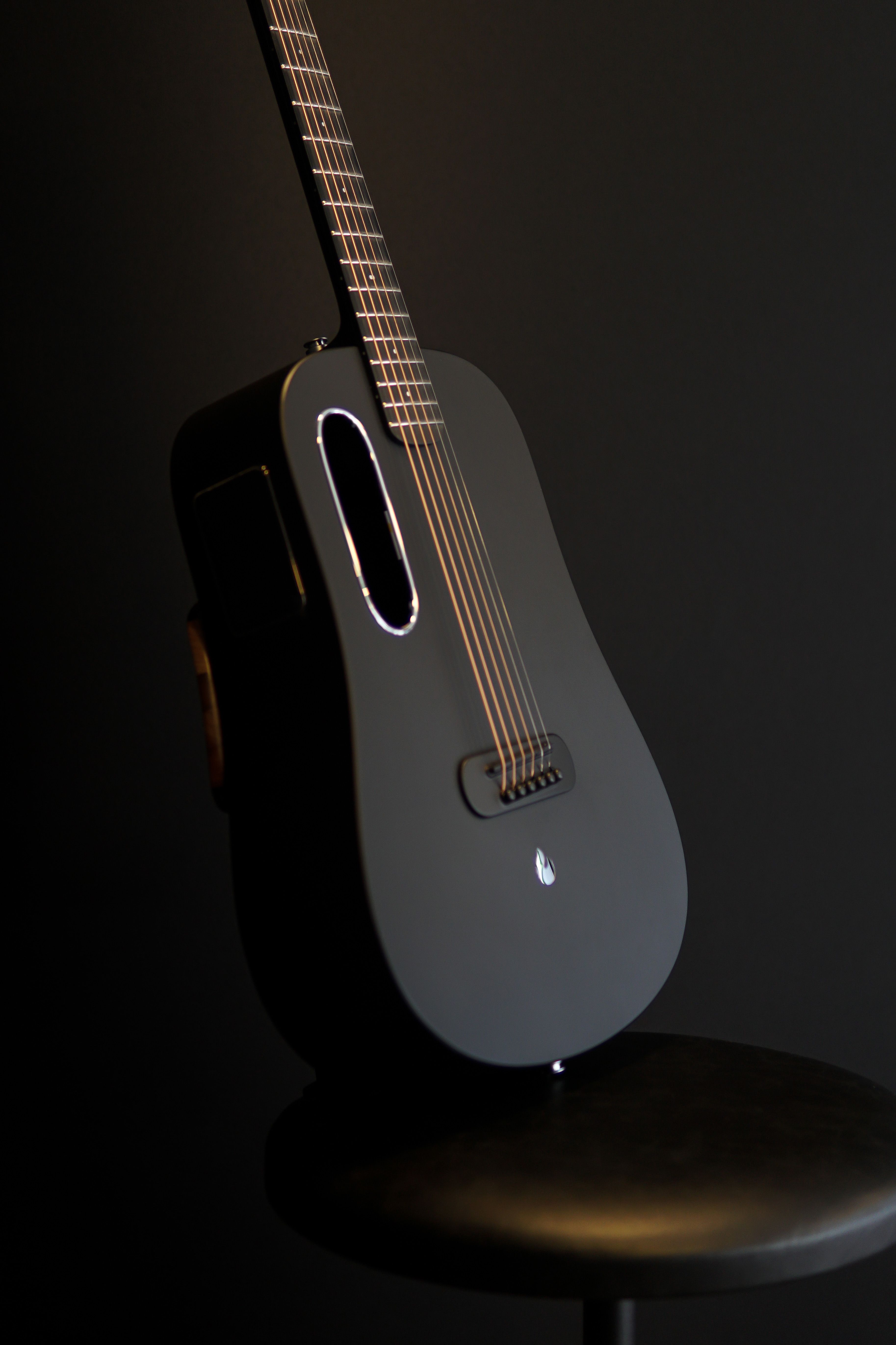 Minimalist Acoustic Guitar on Black Background · Free Stock Photo