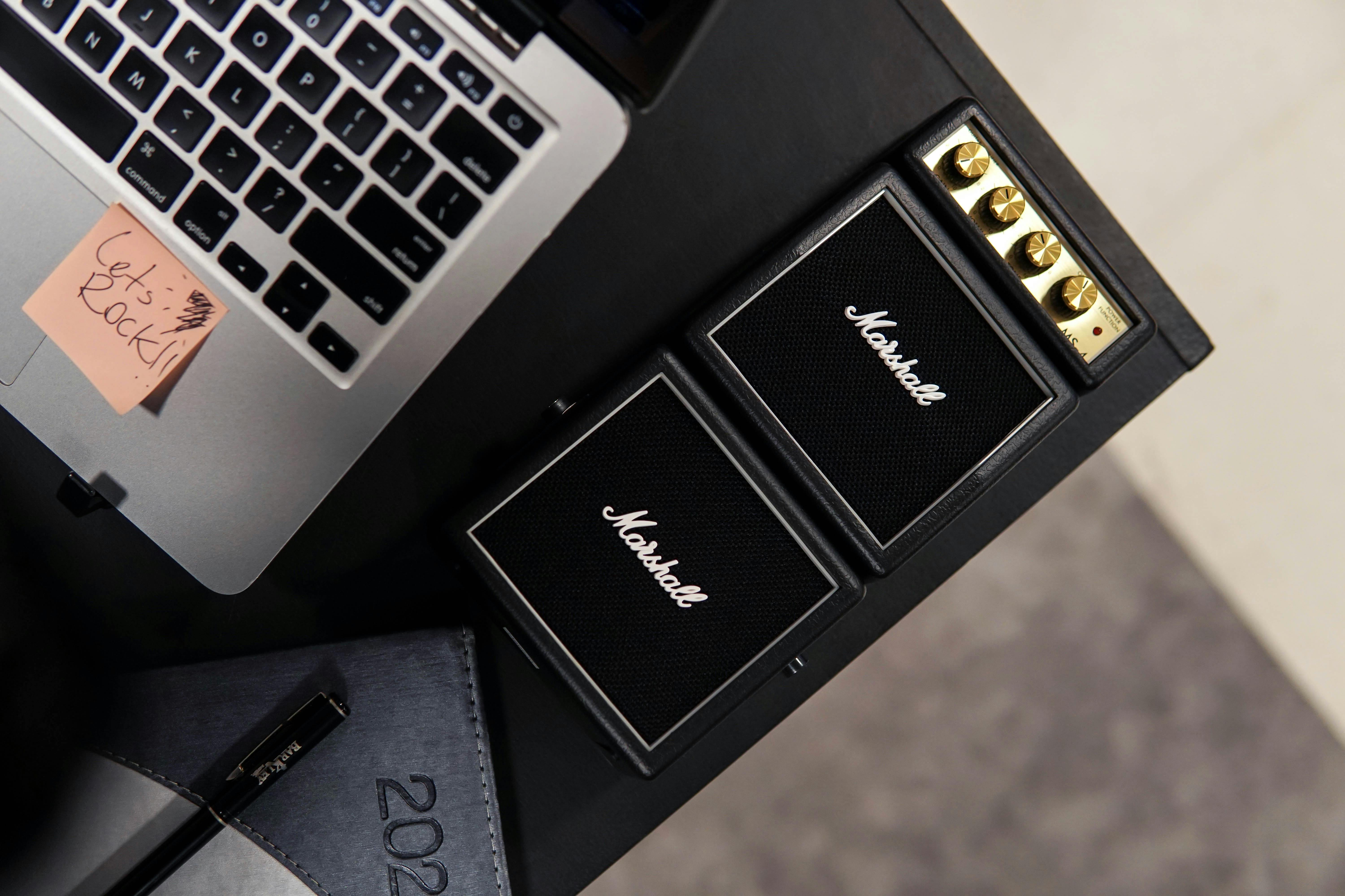 Office Desk with Marshall Music Equipment and Laptop · Free Stock Photo