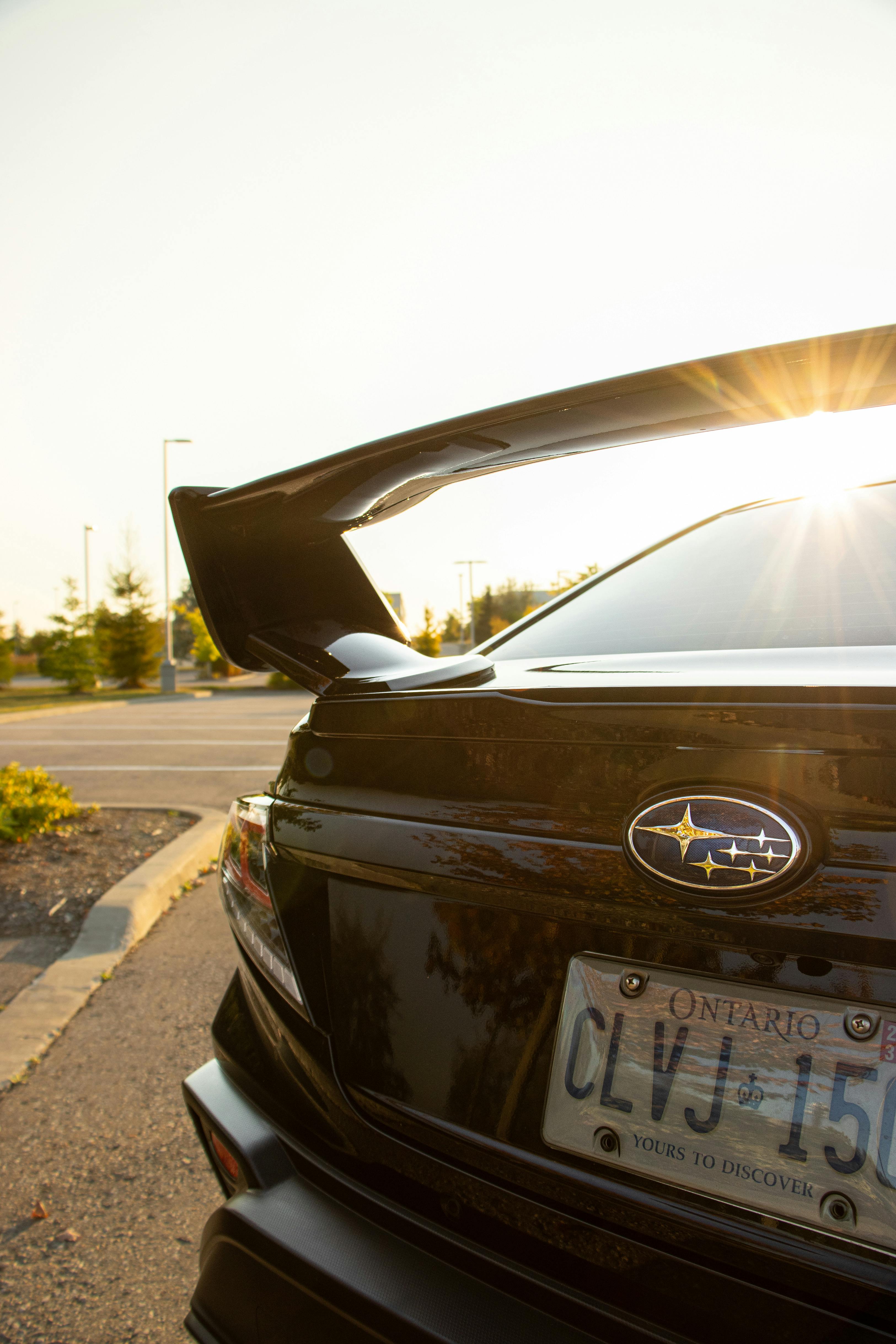 Black Sports Car with Spoiler at Sunset · Free Stock Photo