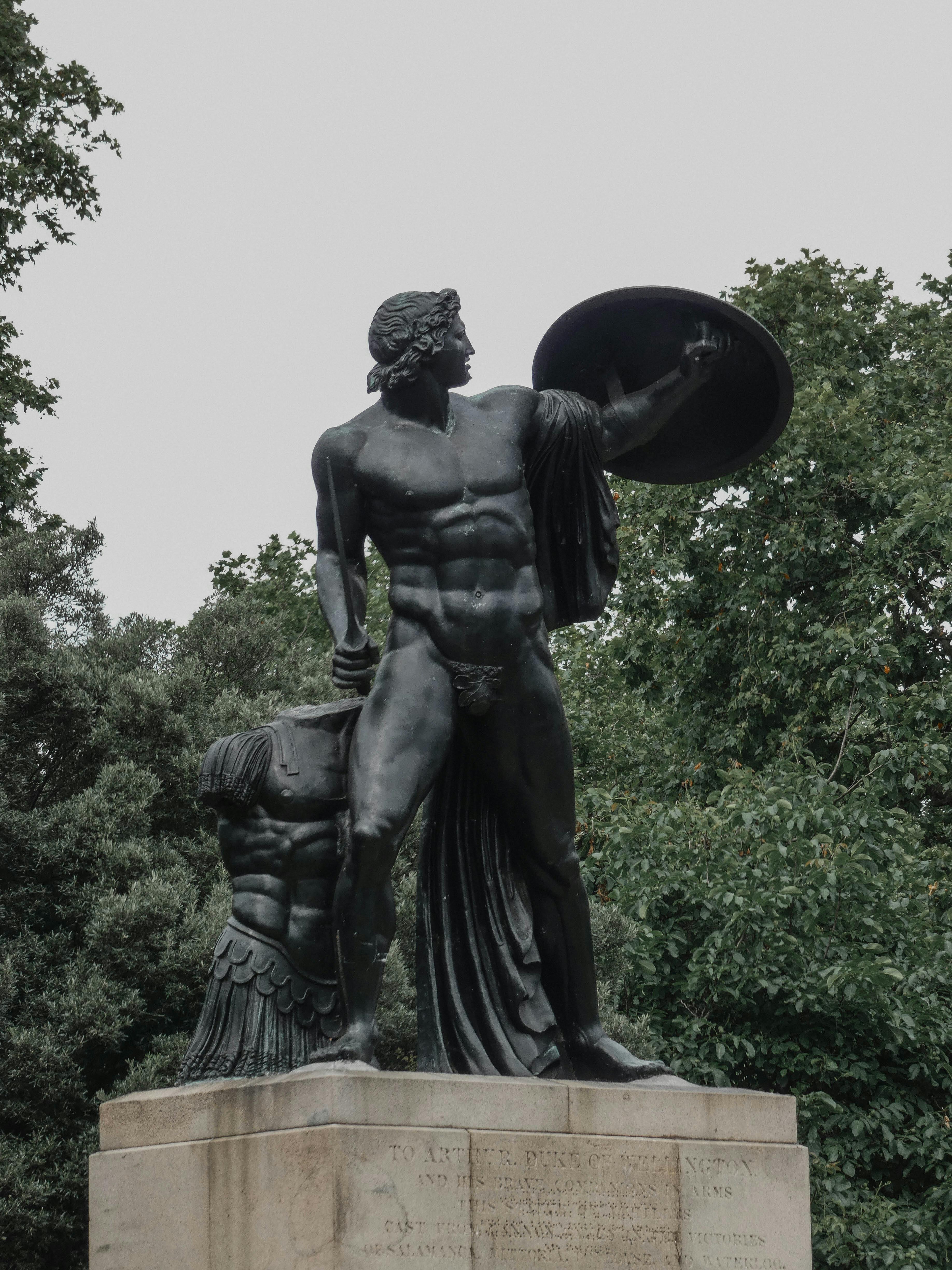 Heroic Bronze Statue in a Lush Park Setting · Free Stock Photo