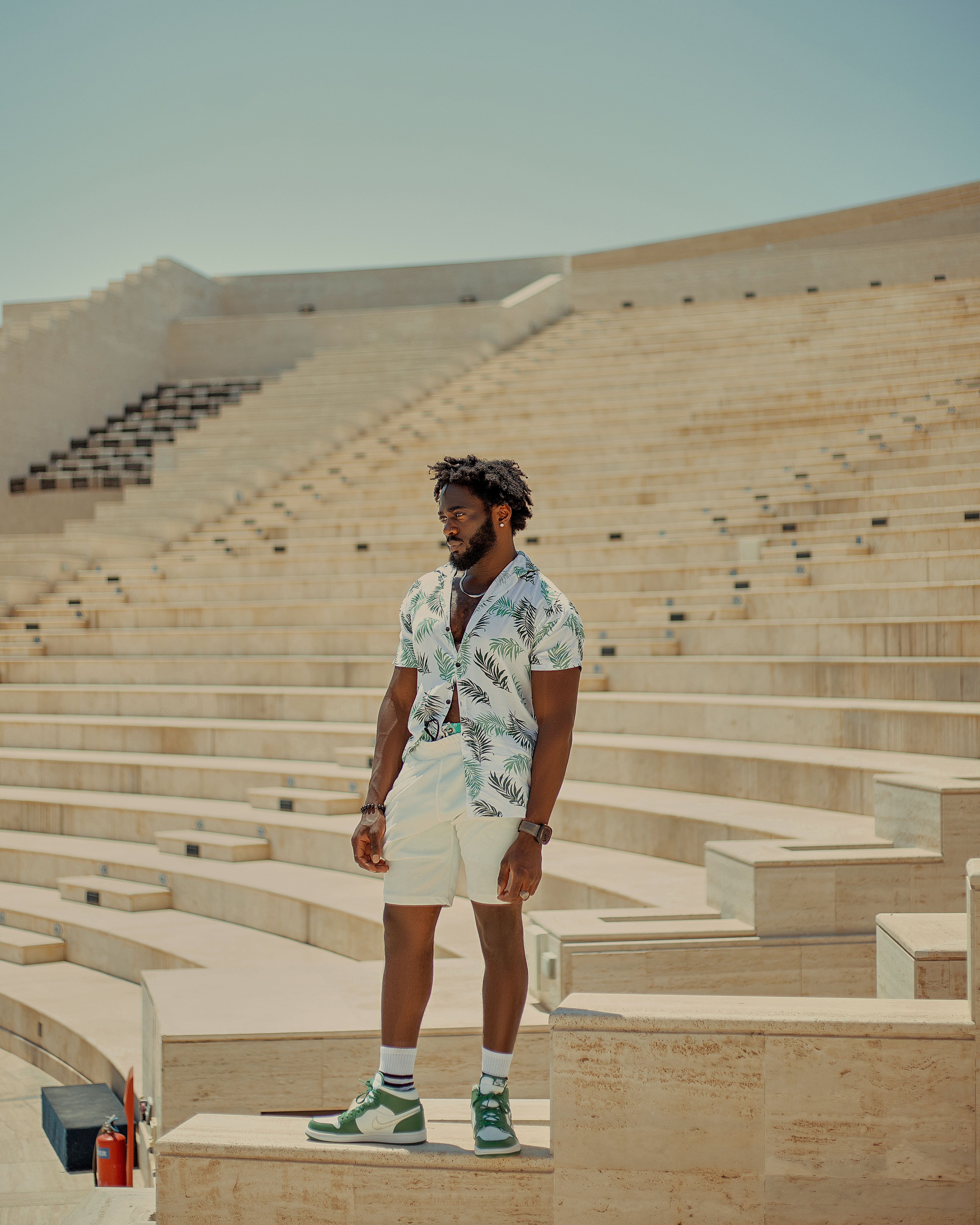 Man Posing in Modern Outdoor Amphitheater · Free Stock Photo