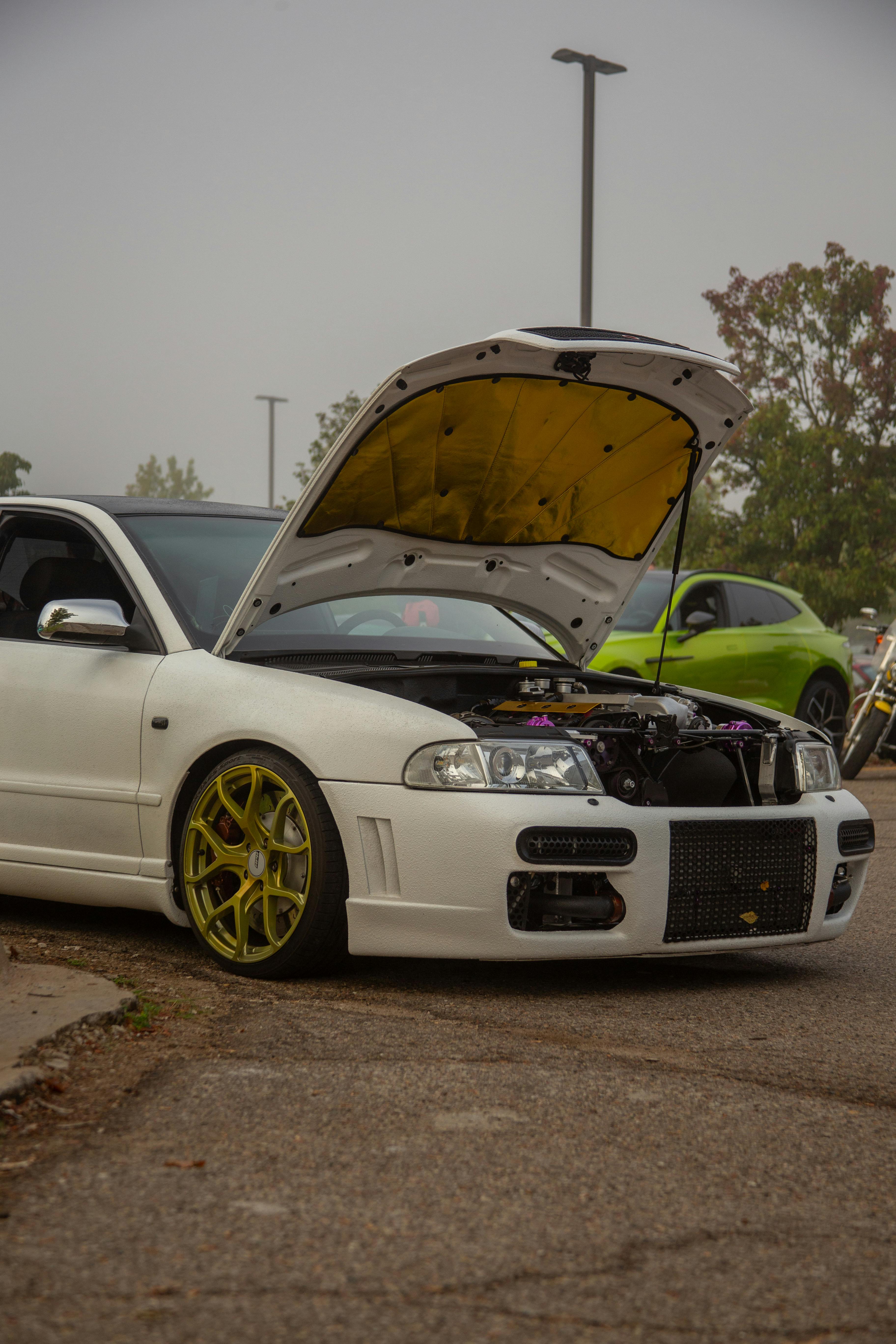 White Modified Car with Open Hood at Outdoor Auto Show · Free Stock Photo