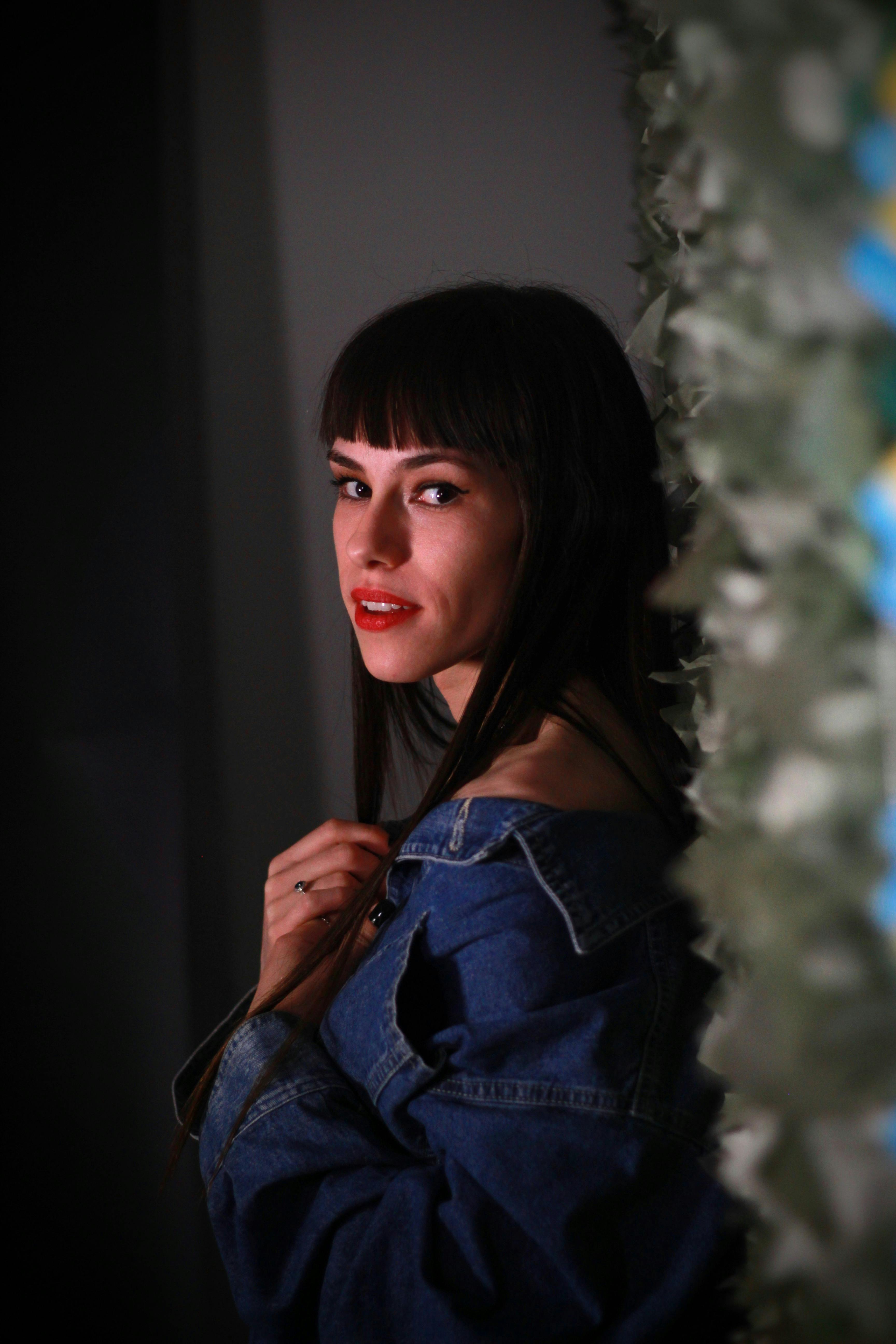Side View Photo of Woman in Denim Jacket Posing · Free Stock Photo