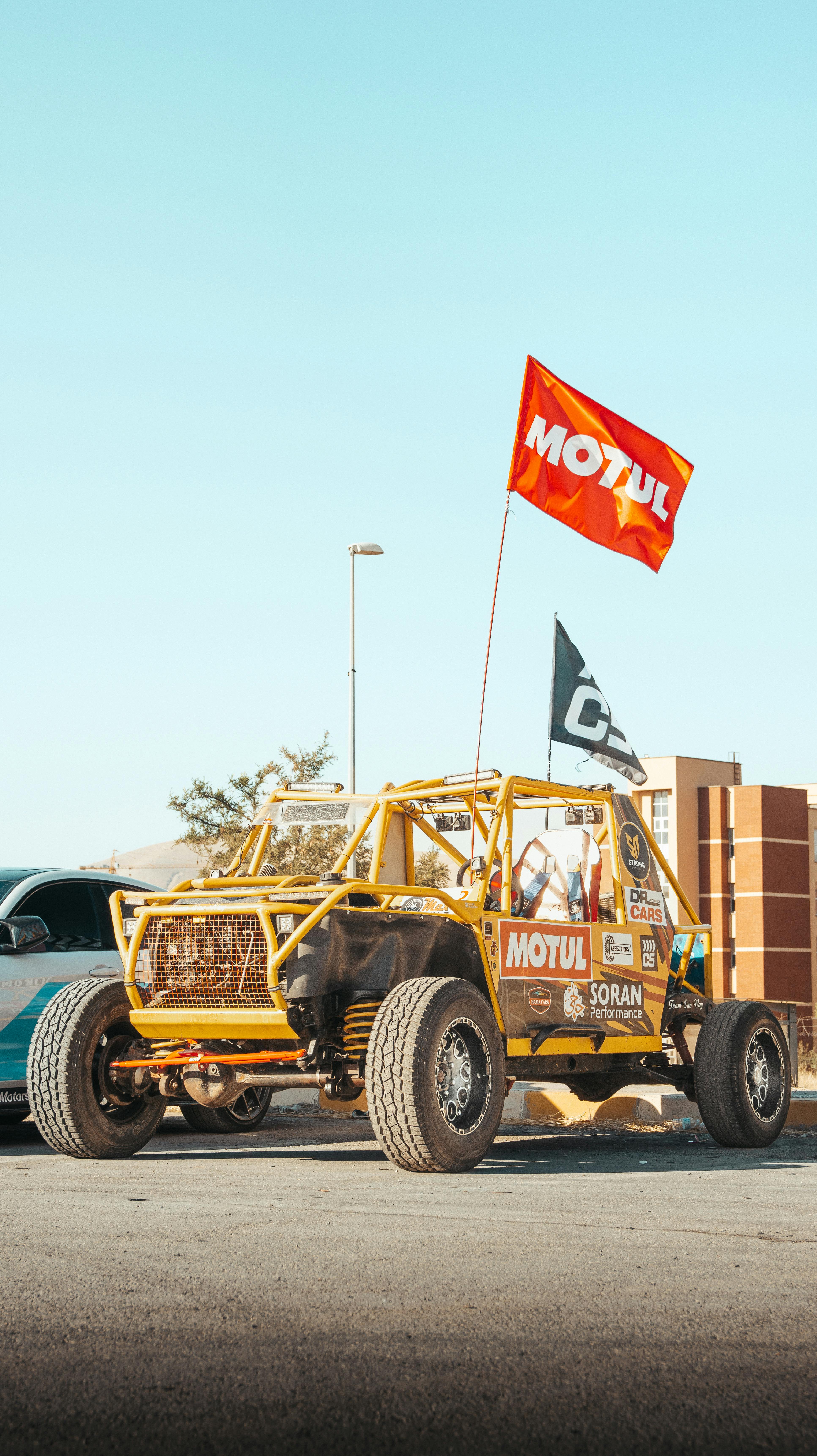 Off-road Buggy with Racing Flags on Display · Free Stock Photo